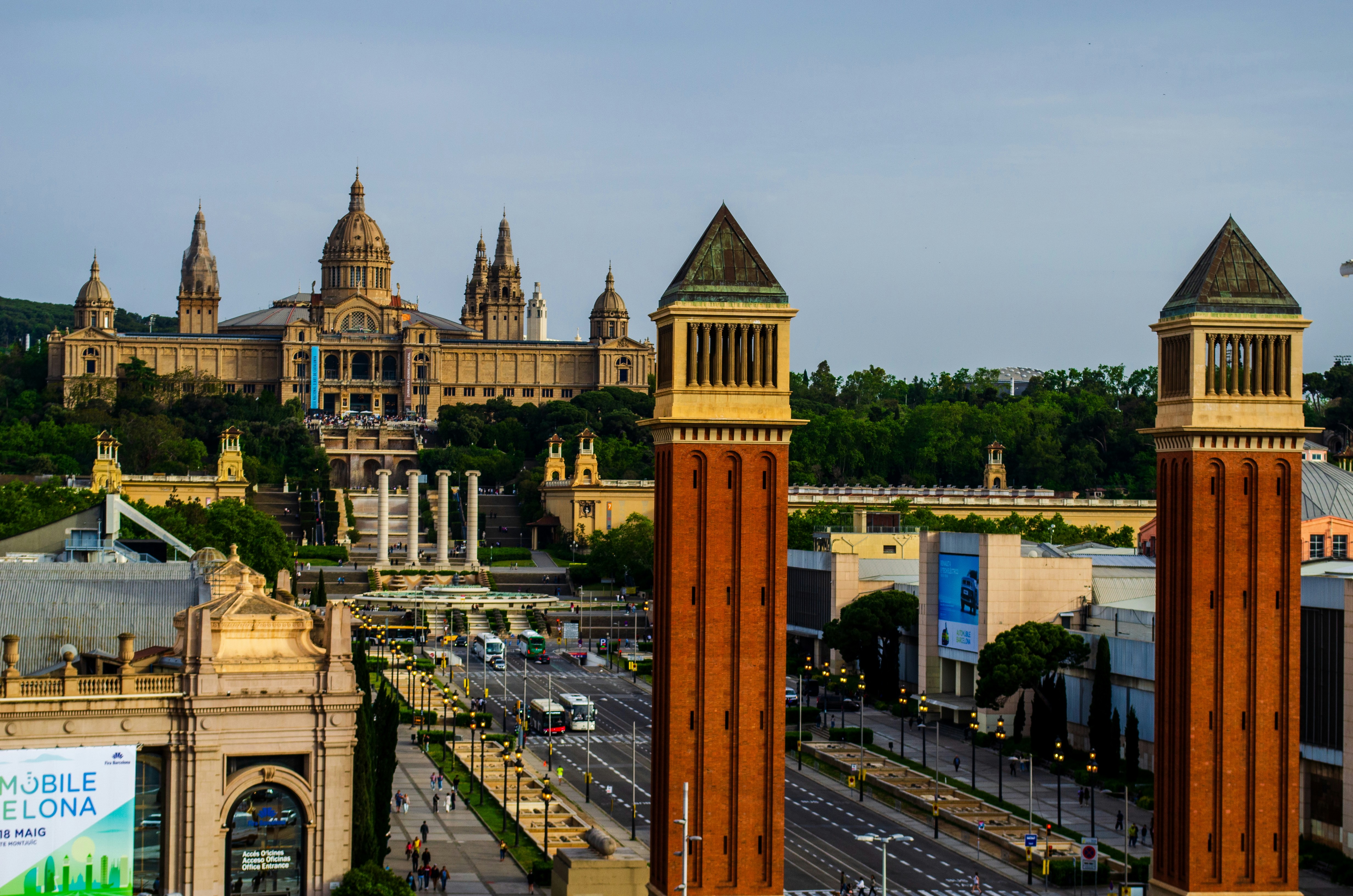 Catalan Giants Overlooking Avenues: The Modern Plaza Framed by Historic Towers