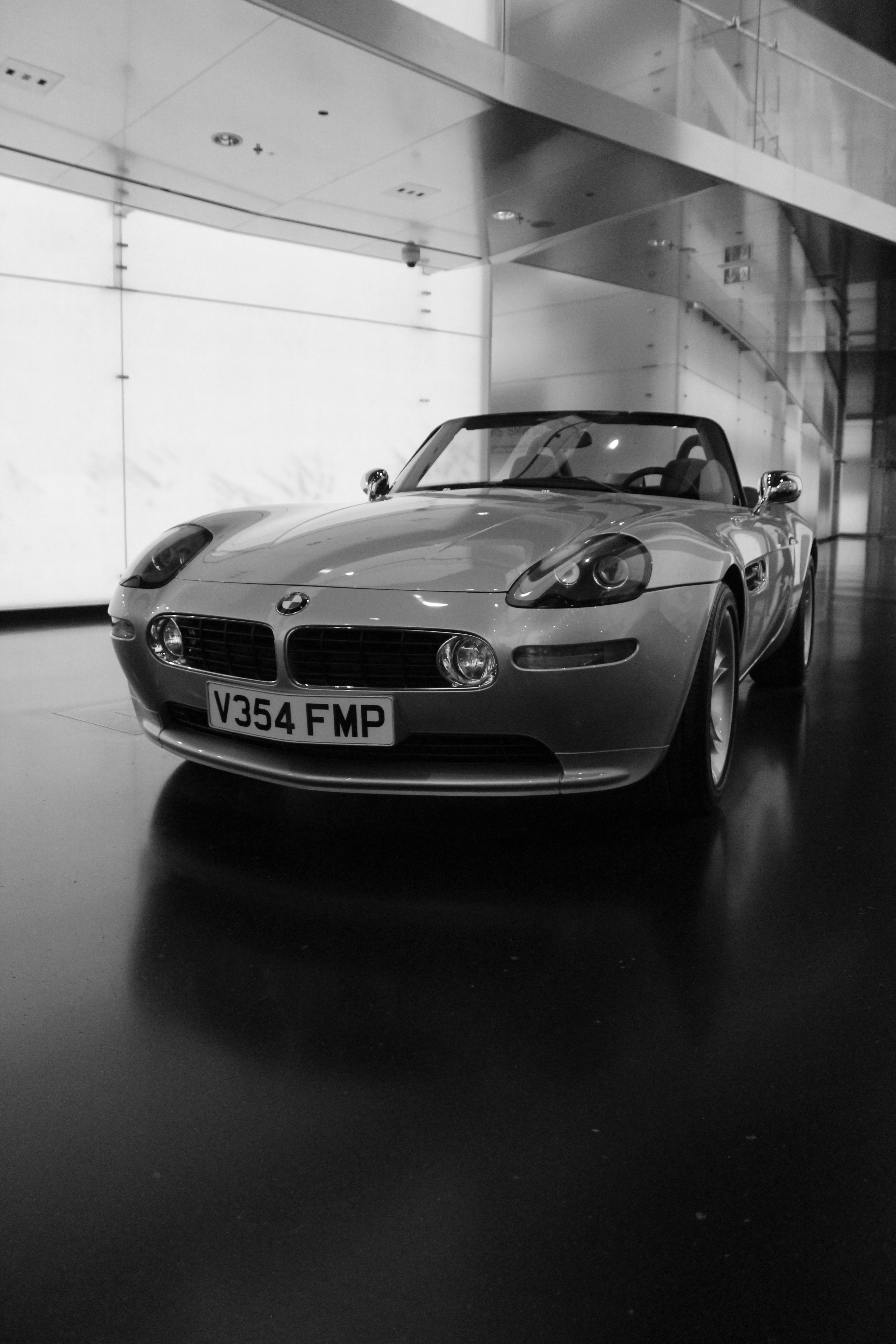 A BMW z8 roadster is showcased indoors.