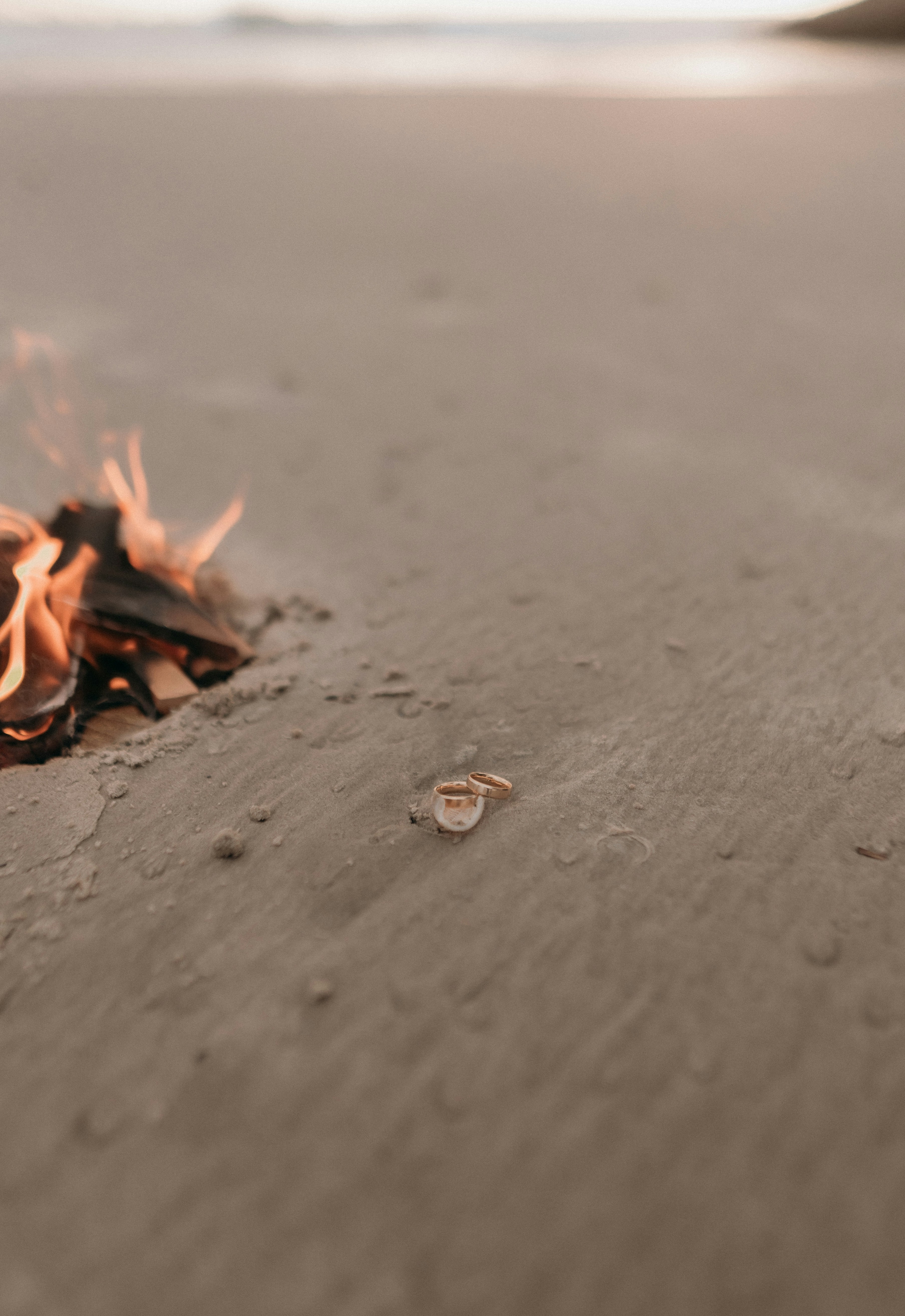 Ember on Sand: Two Rings in a Quiet Beach Moment