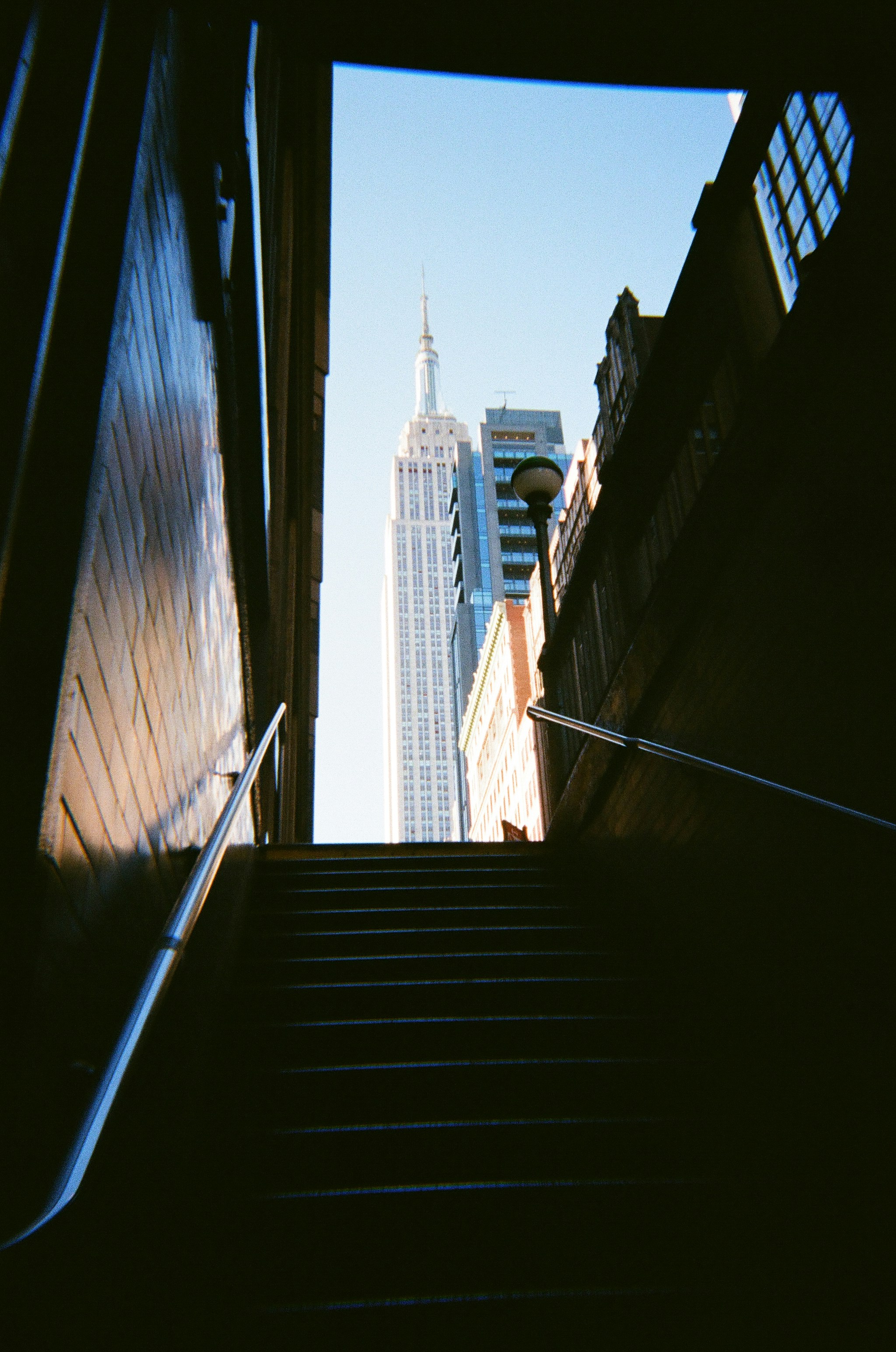Looking up stairs towards the empire state building. photo – Free Dark ...