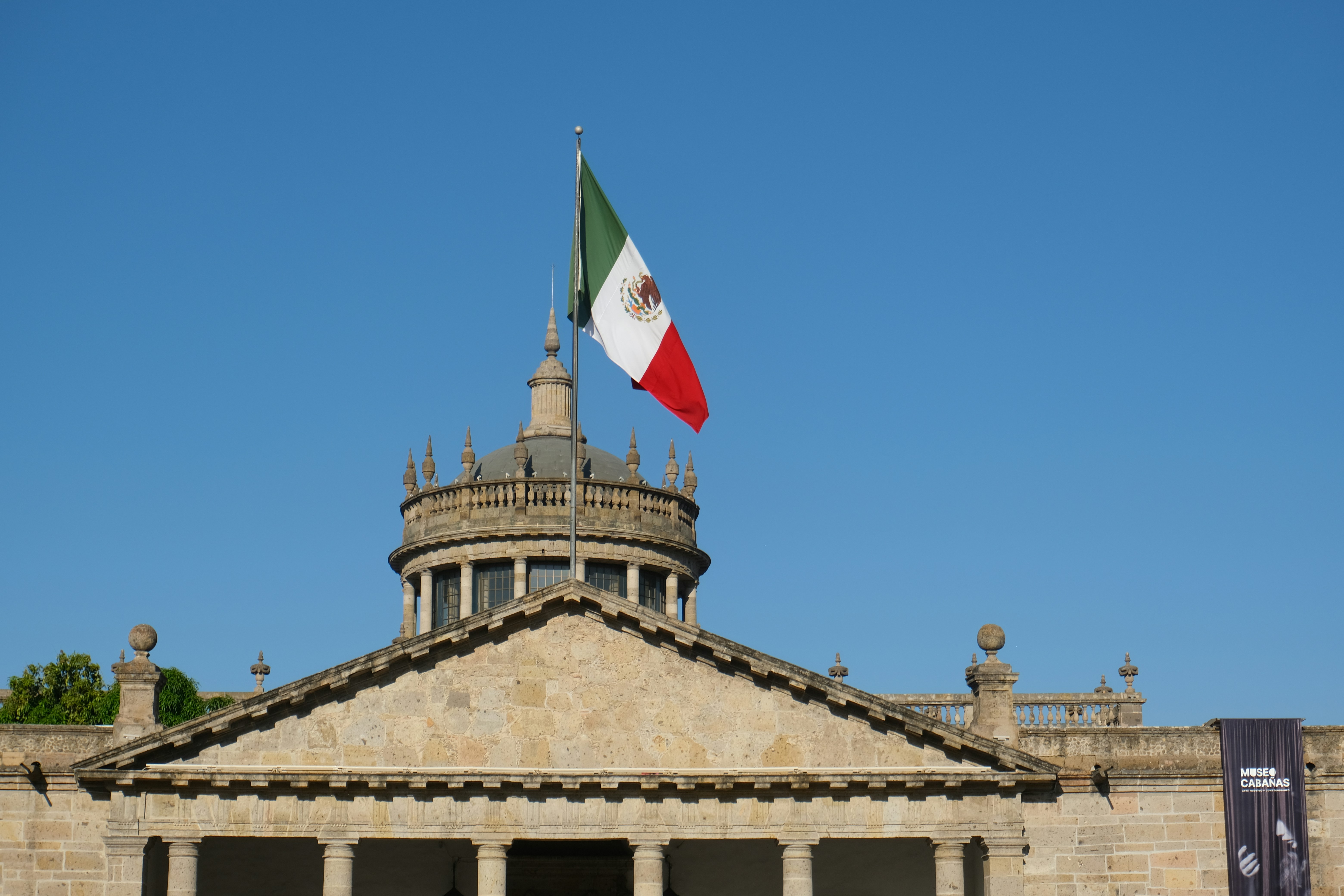 Flag at the Crown of a Colonial Rotunda Under Azure Sky