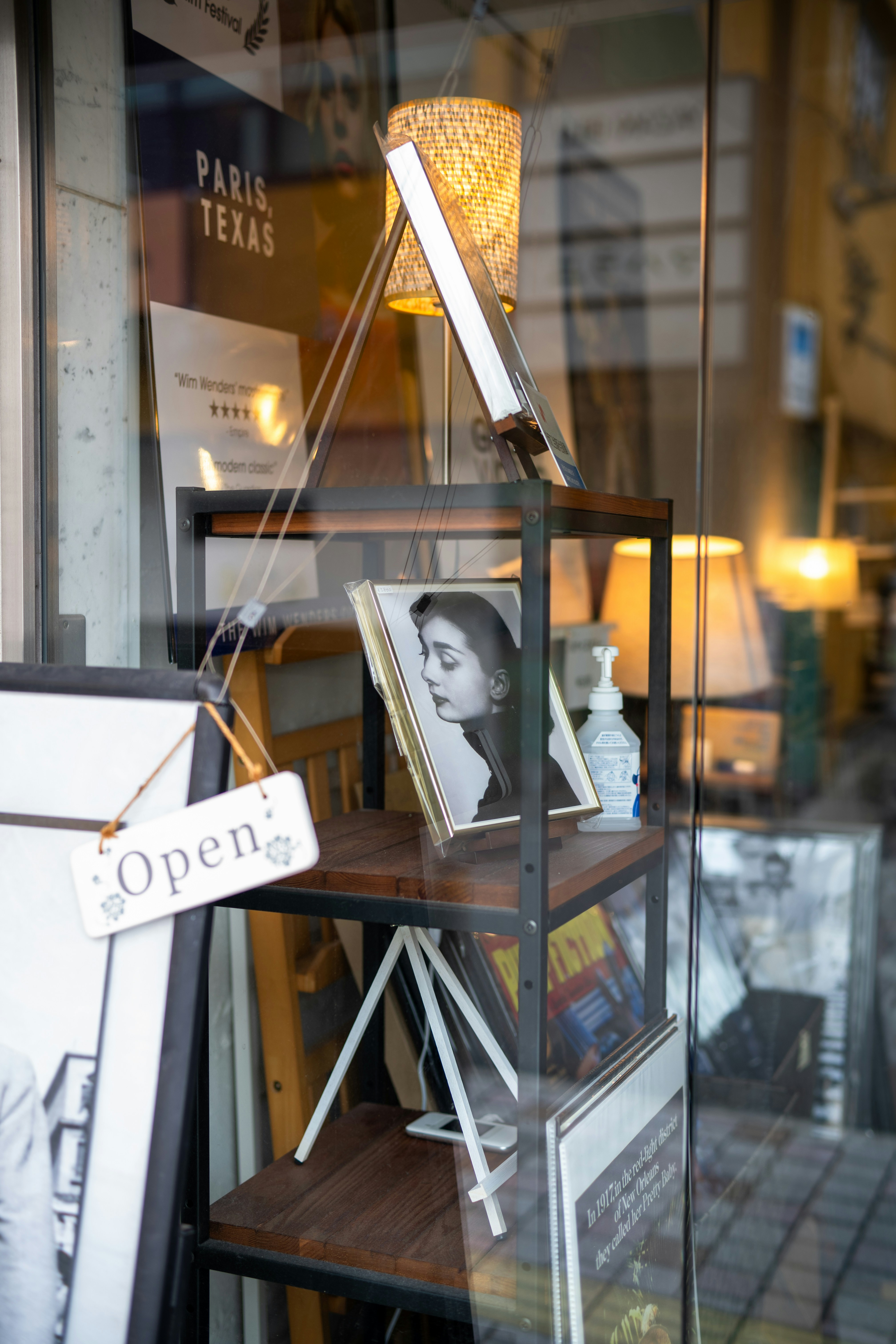 A storefront window displays vintage items and decorations. photo ...