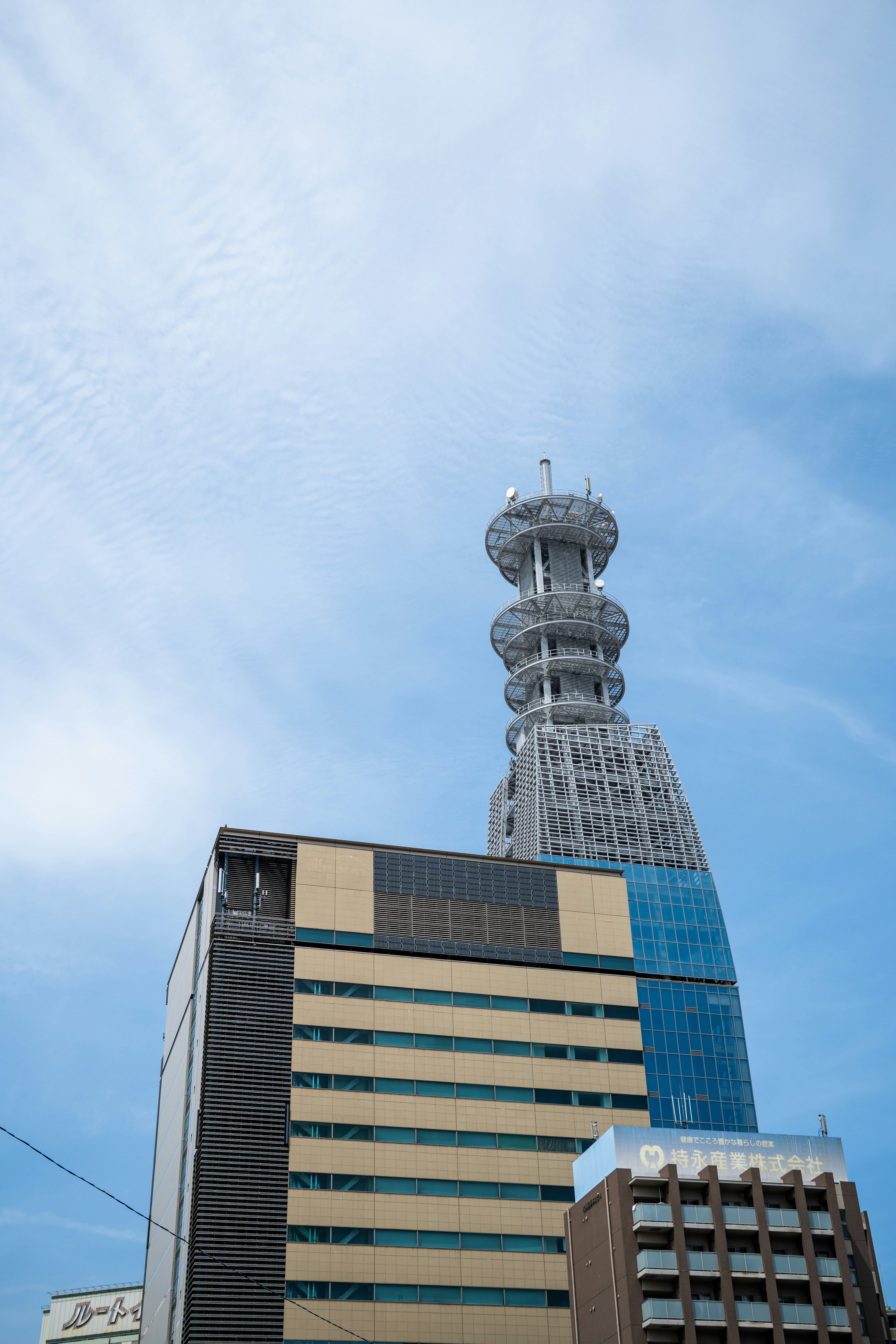 Buildings and a tower stretch towards the bright blue sky. photo – Free ...