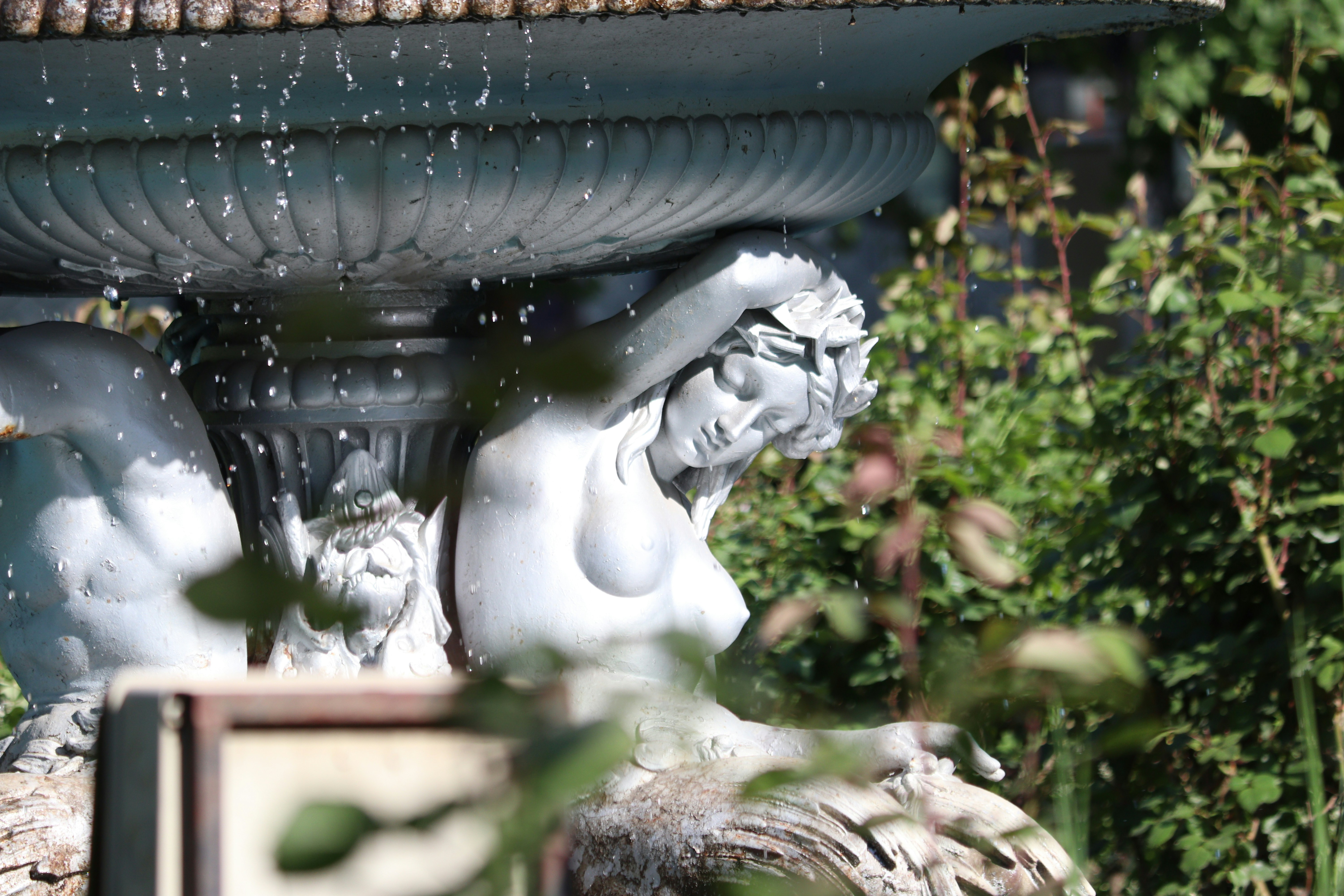 Silent Marble Muse Beneath a Water-Trimmed Fountain