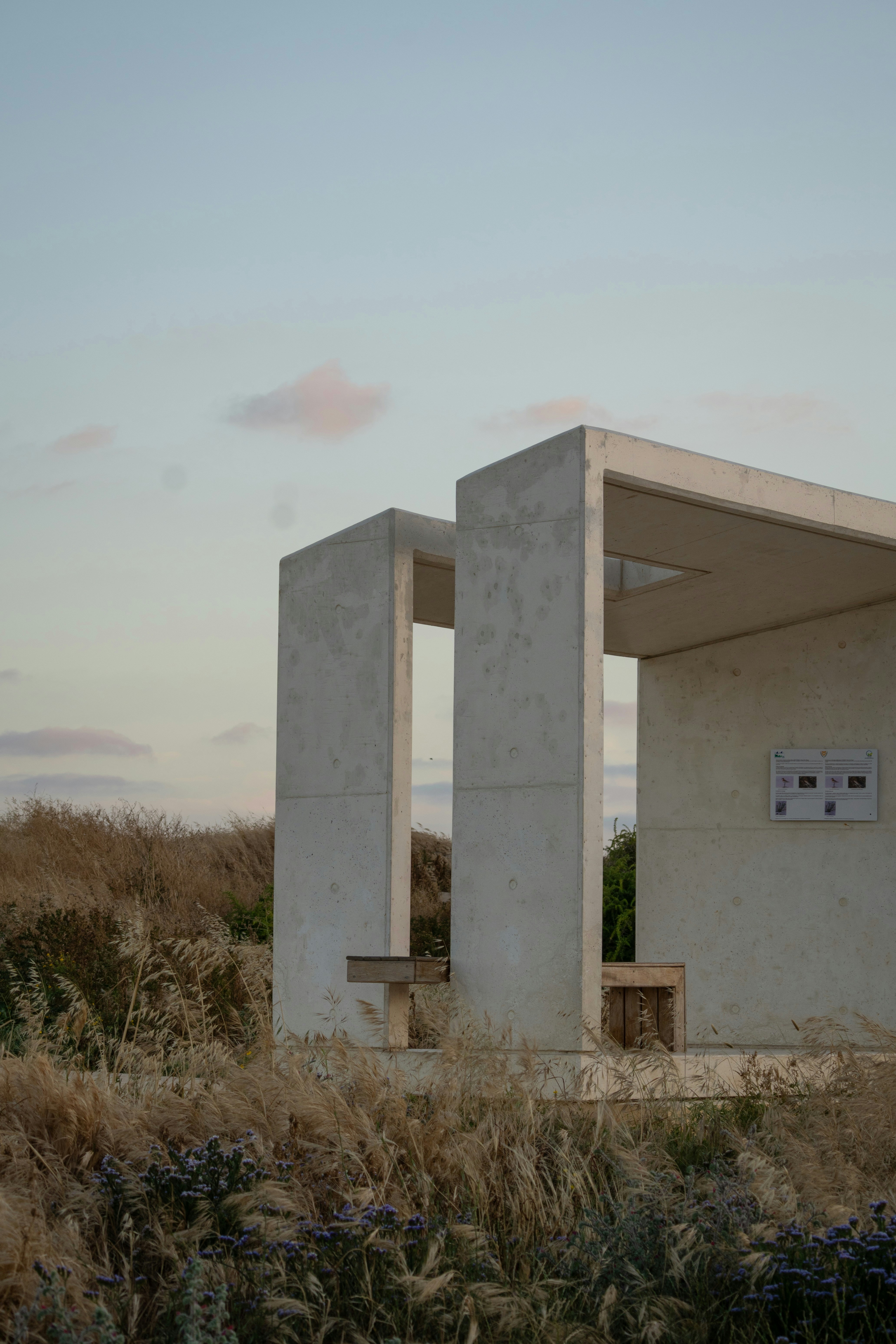Sunlit Geometry: Concrete Pavilions Framed by Prairie Grasses