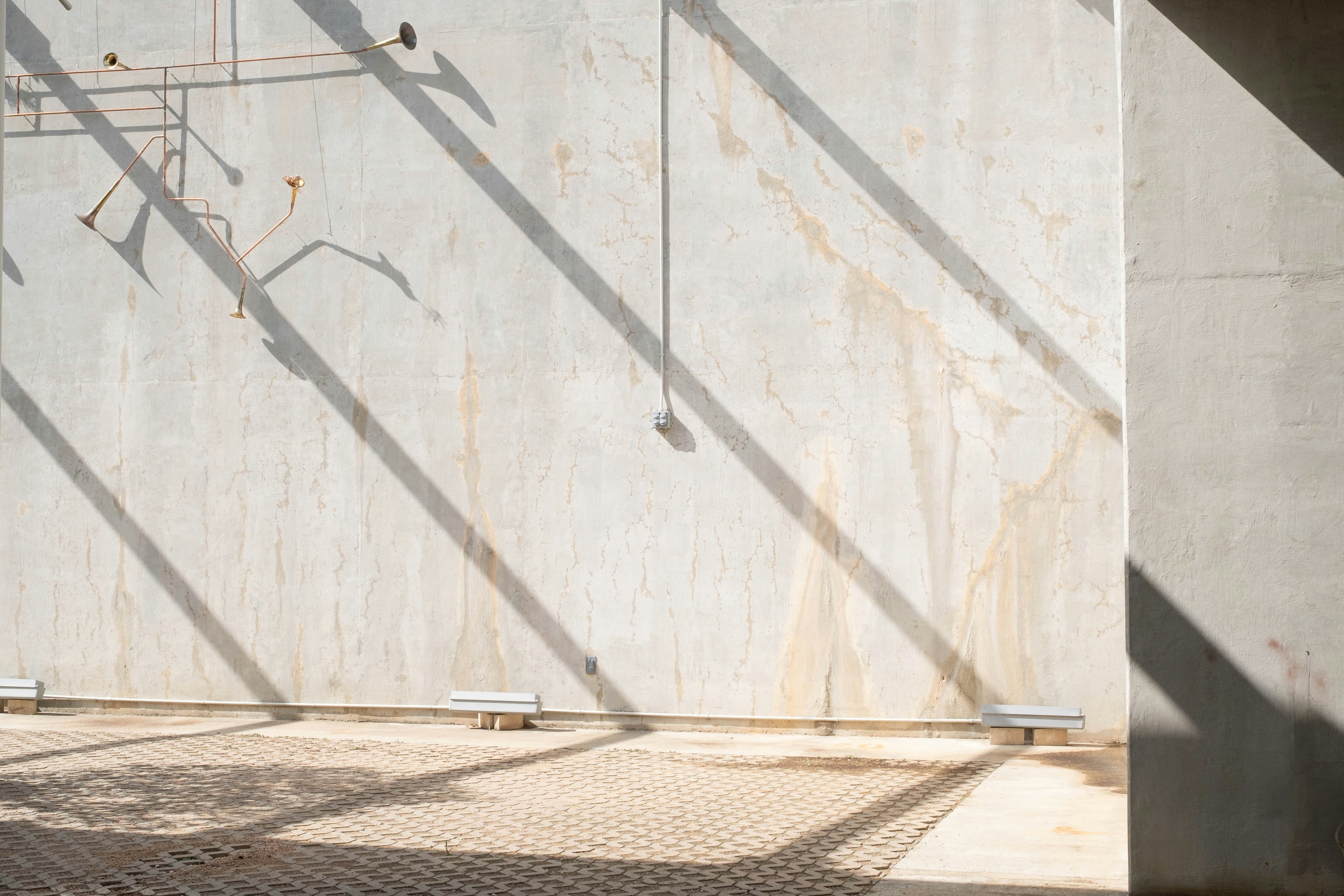 Shadows create interesting patterns on a concrete wall. photo – Free ...