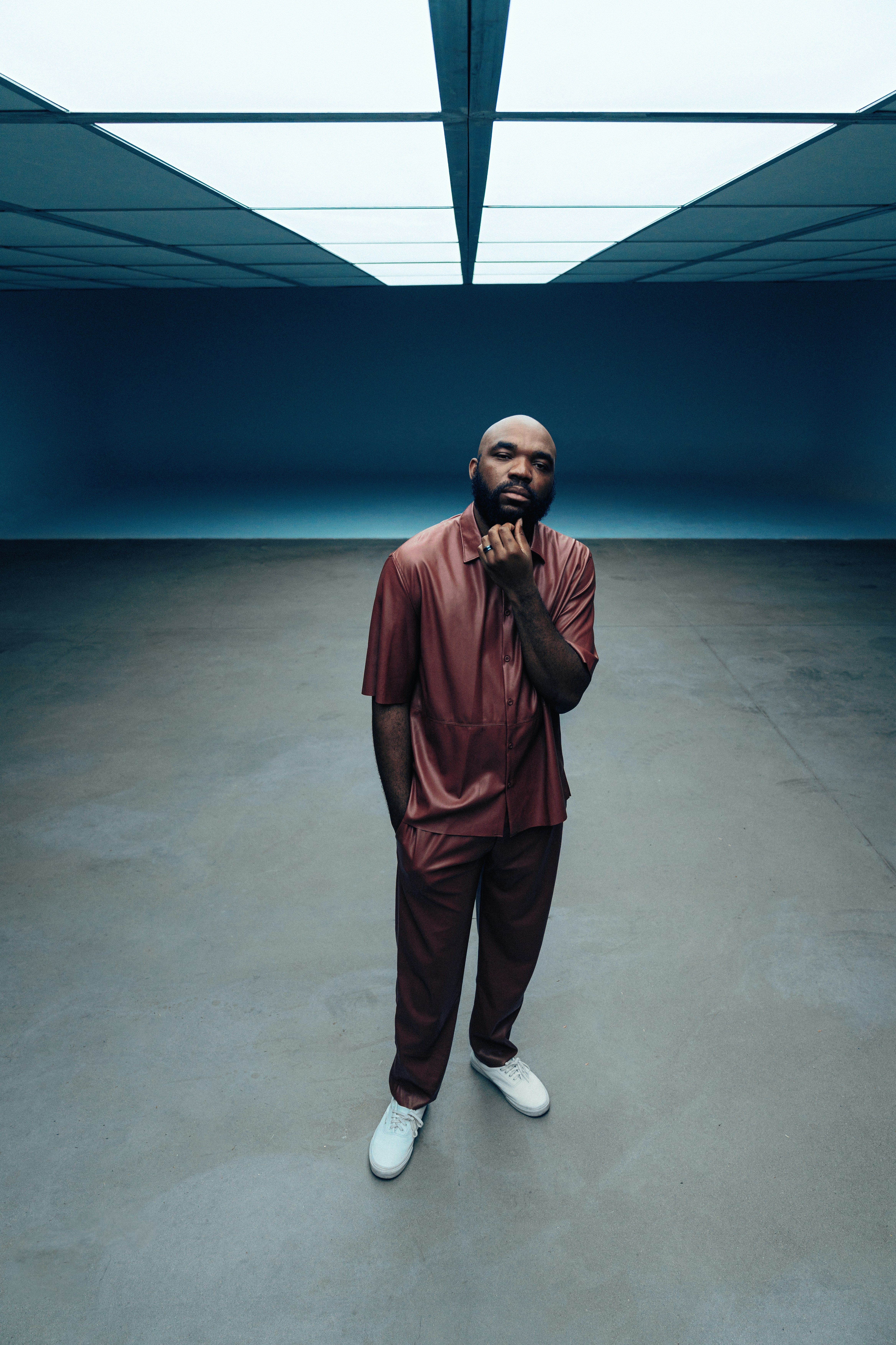 A man poses thoughtfully in a minimalist space. photo – Free Abstract ...