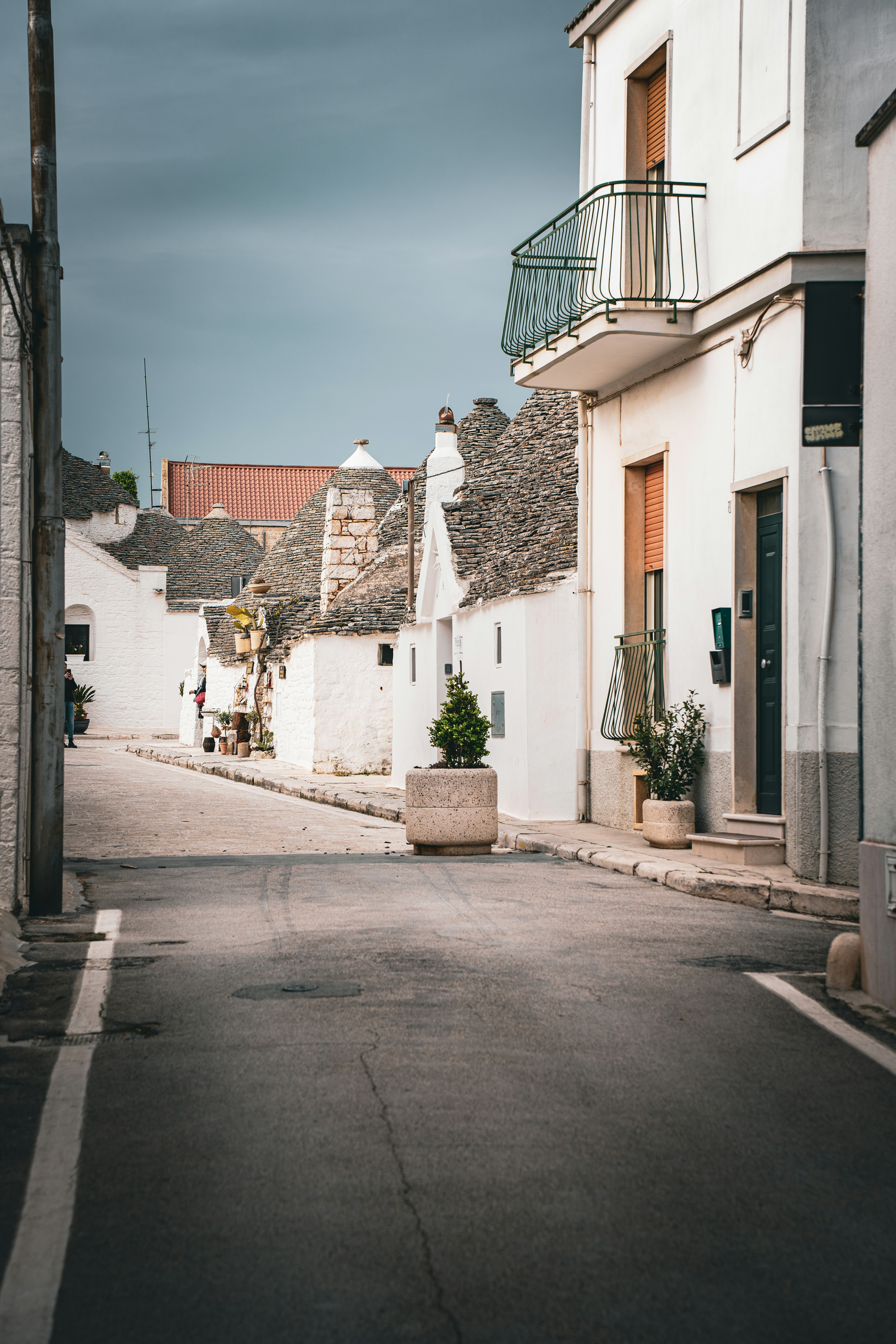 Quaint italian street lined with white buildings. photo – Free Travel ...
