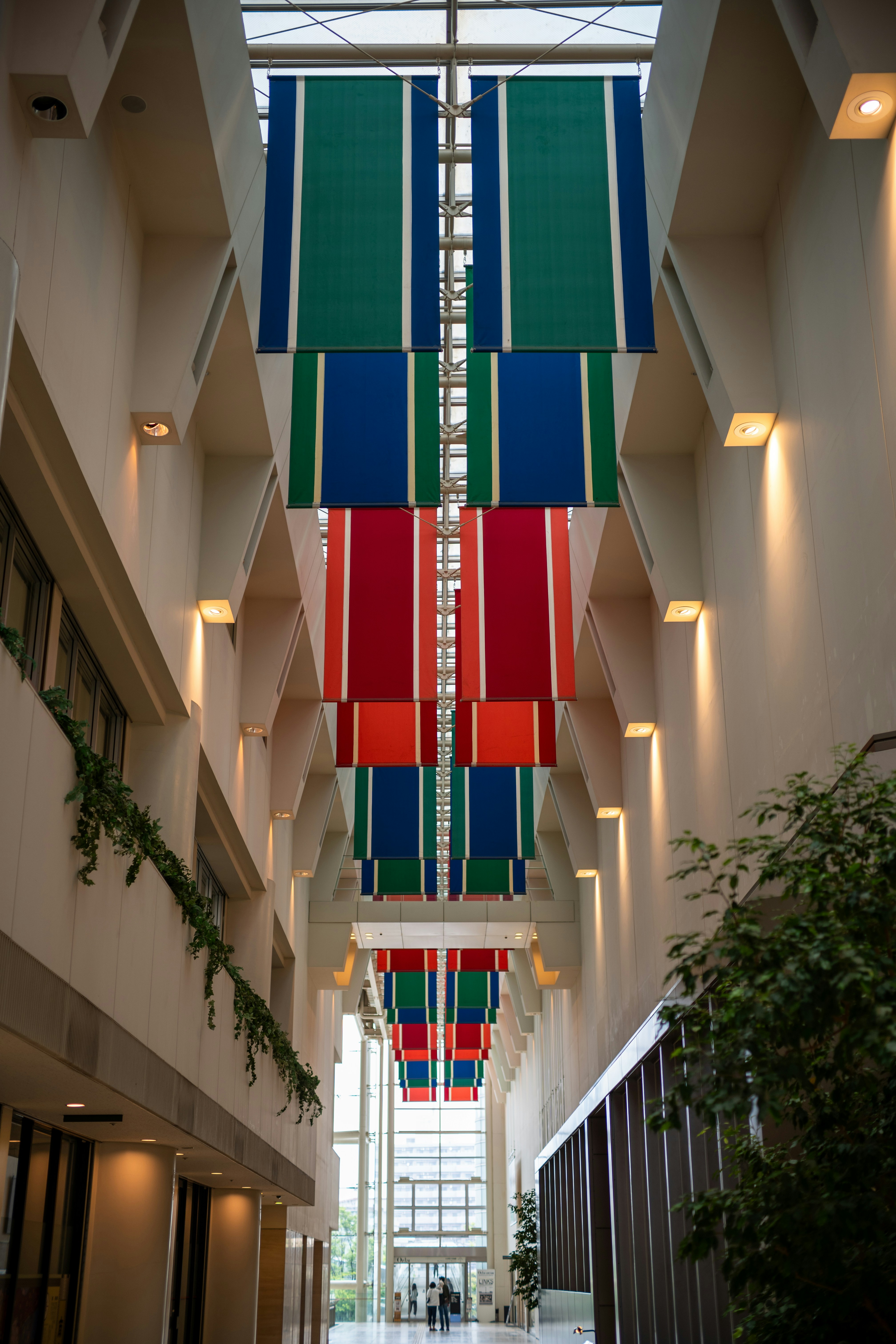 Colorful banners decorate a long, open hallway. photo – Free Image on ...