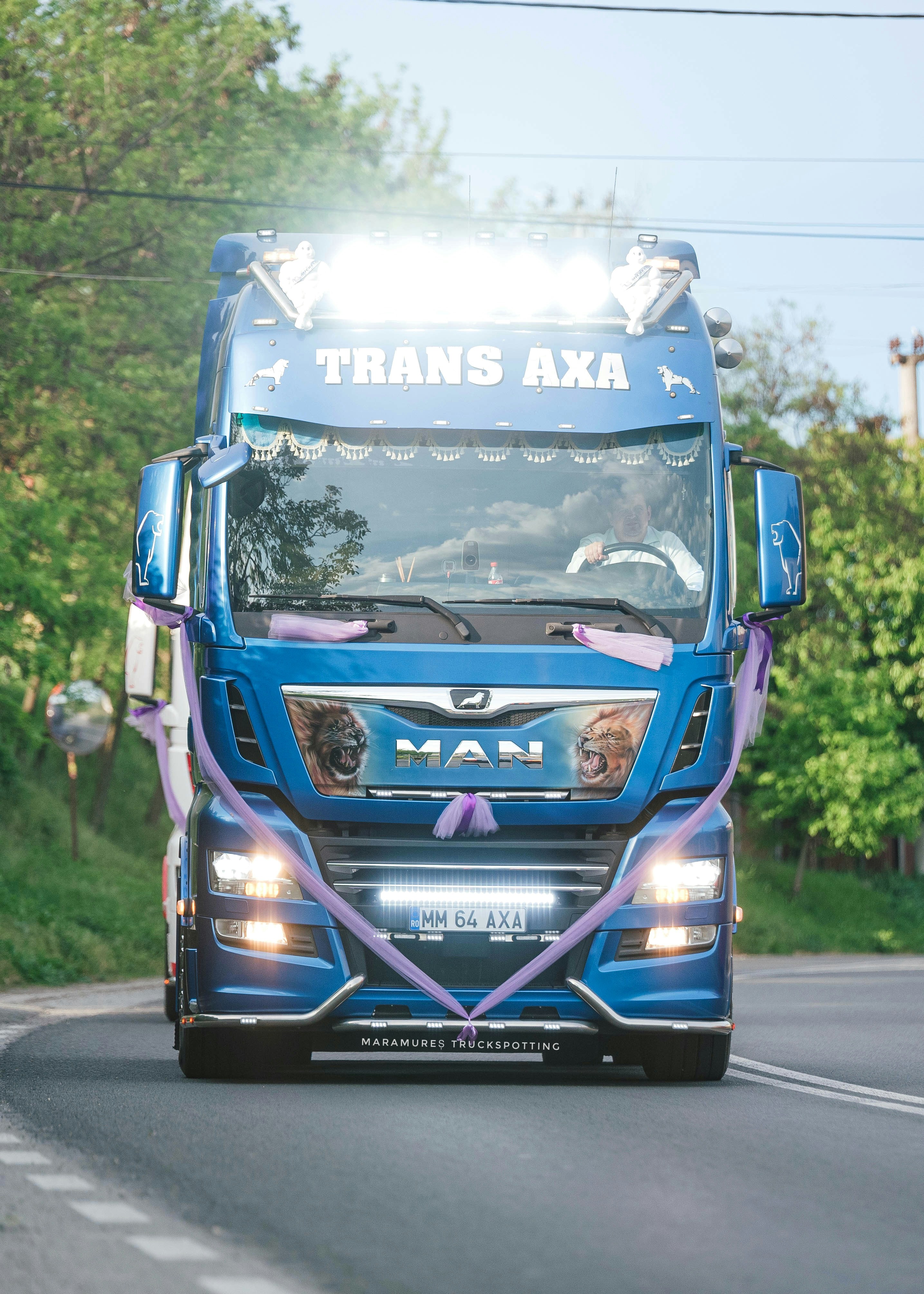 Blue Trans AXA Truck Parade: A Front-Focused Spectacle