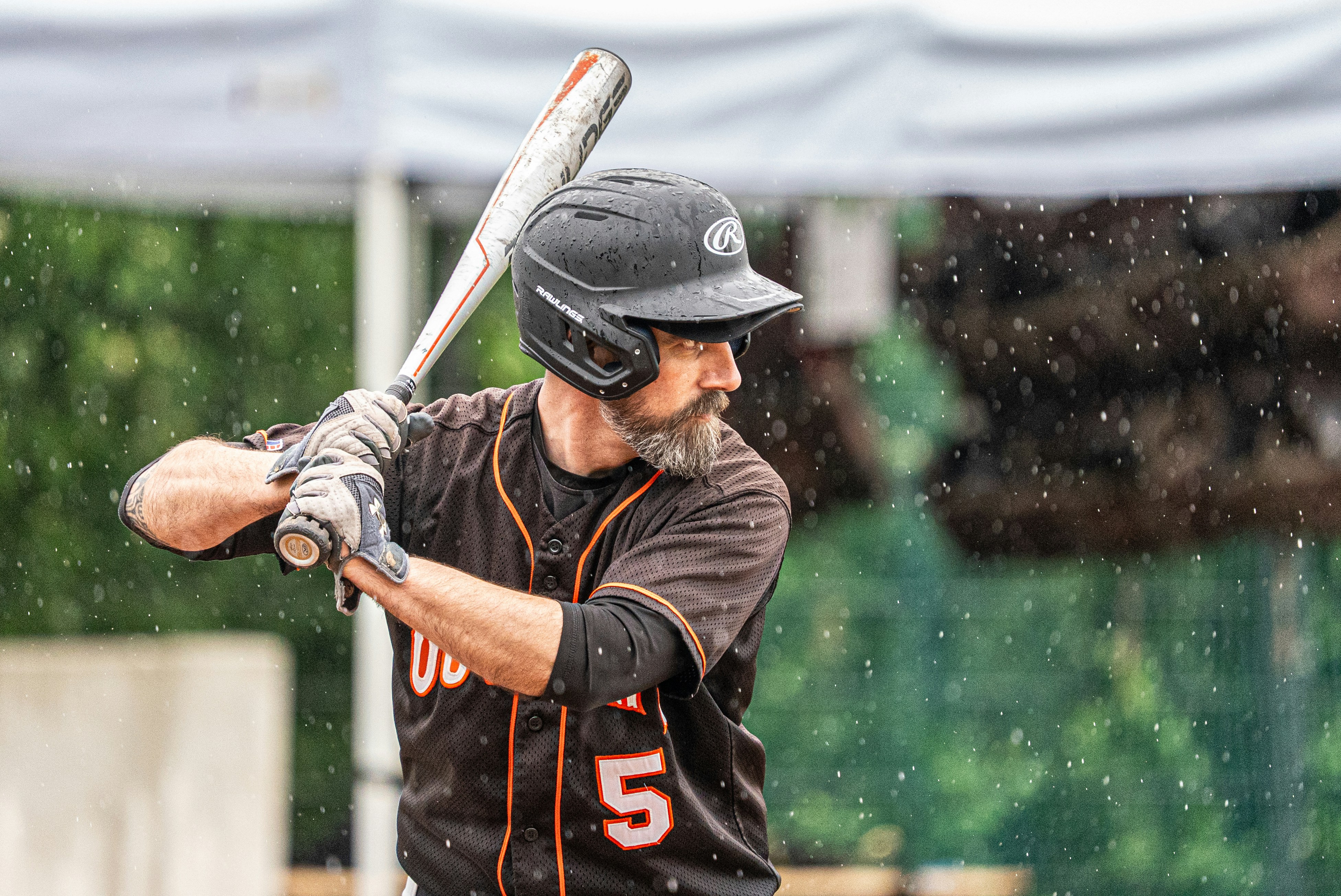 Baseball player ready to swing the bat in the rain. photo – Free People ...