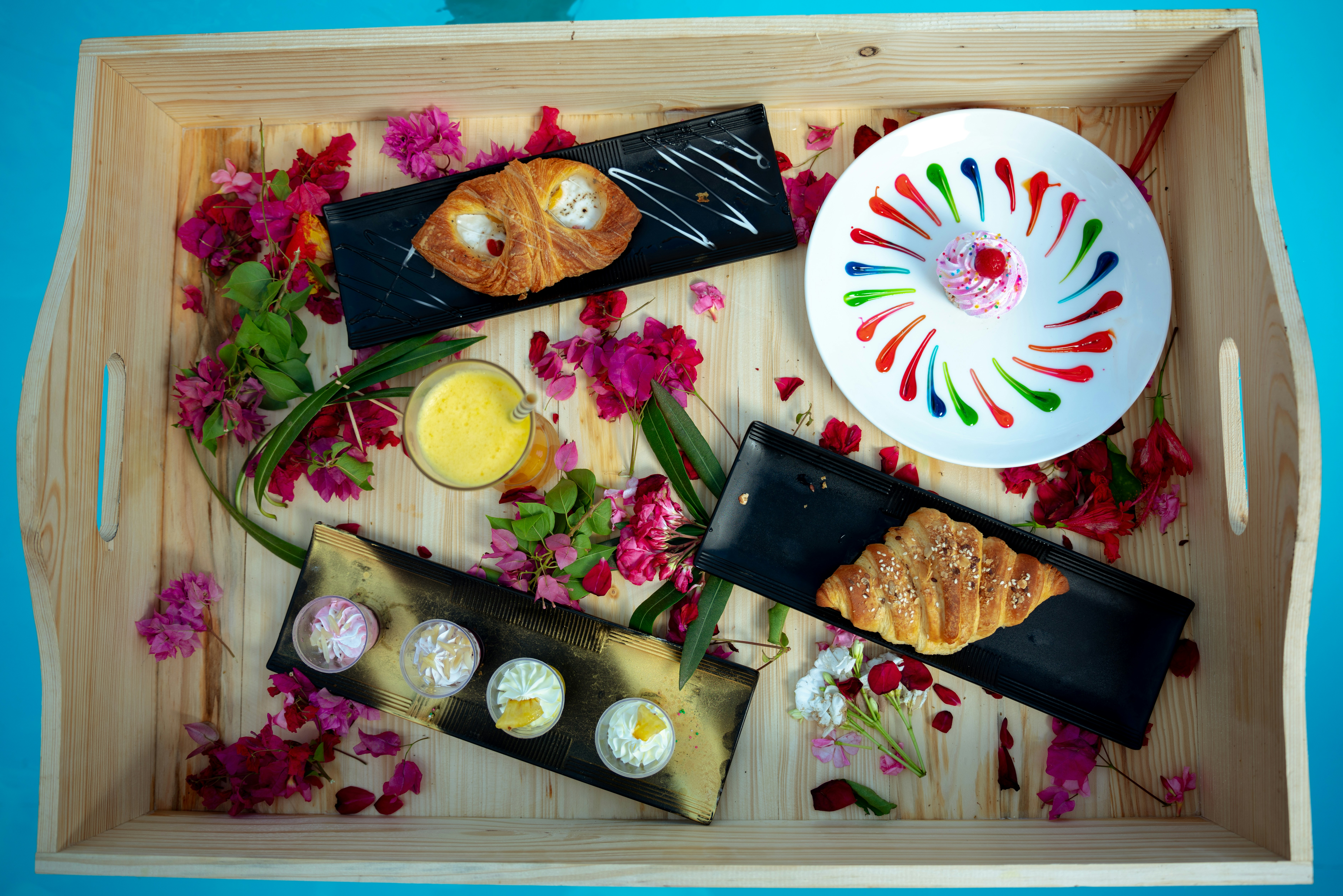 Floral Feast on a Wooden Tray: Sweet Treats and Colorful Artistry