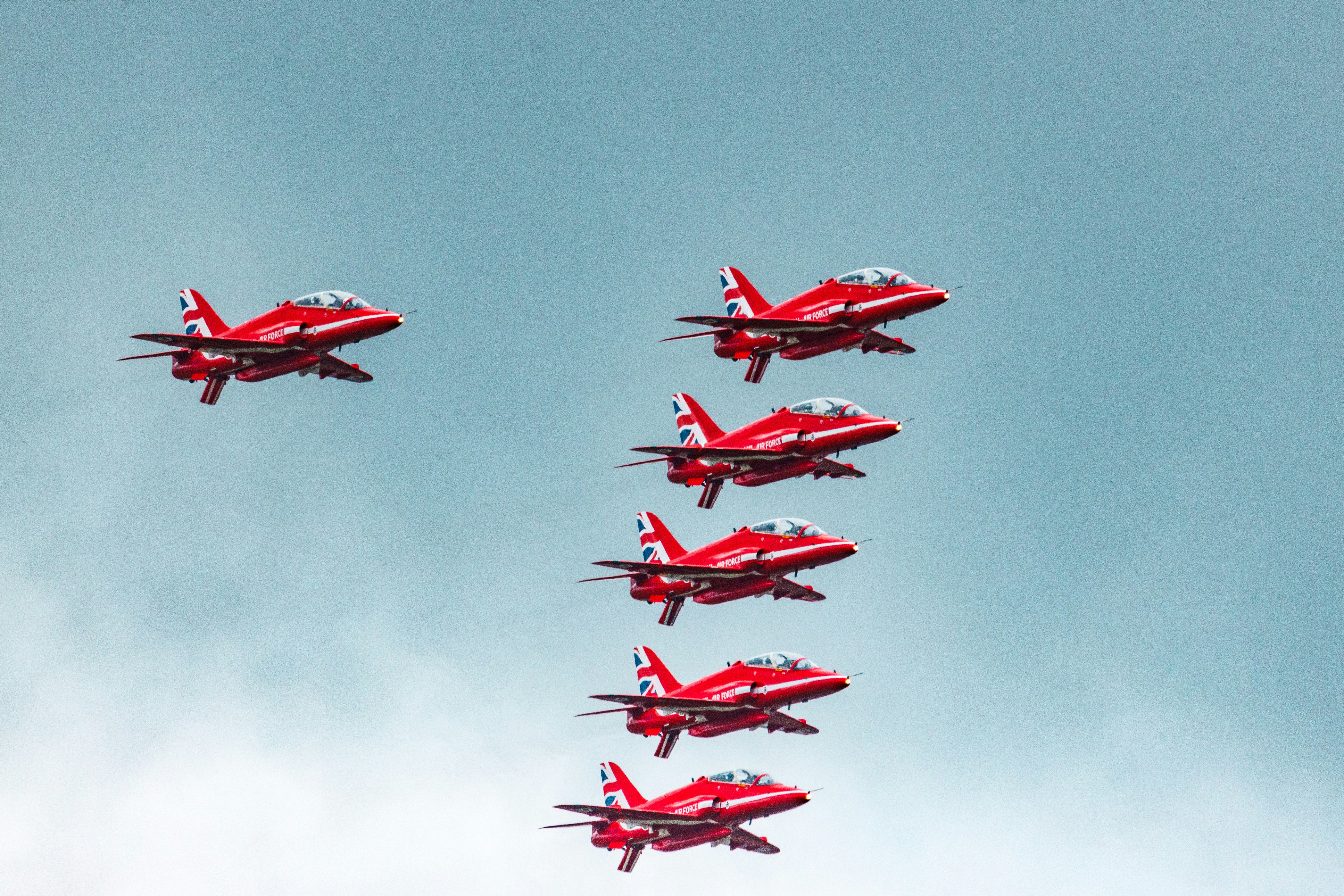 Red arrows perform an aerial display. photo – Free Ilford Image on Unsplash