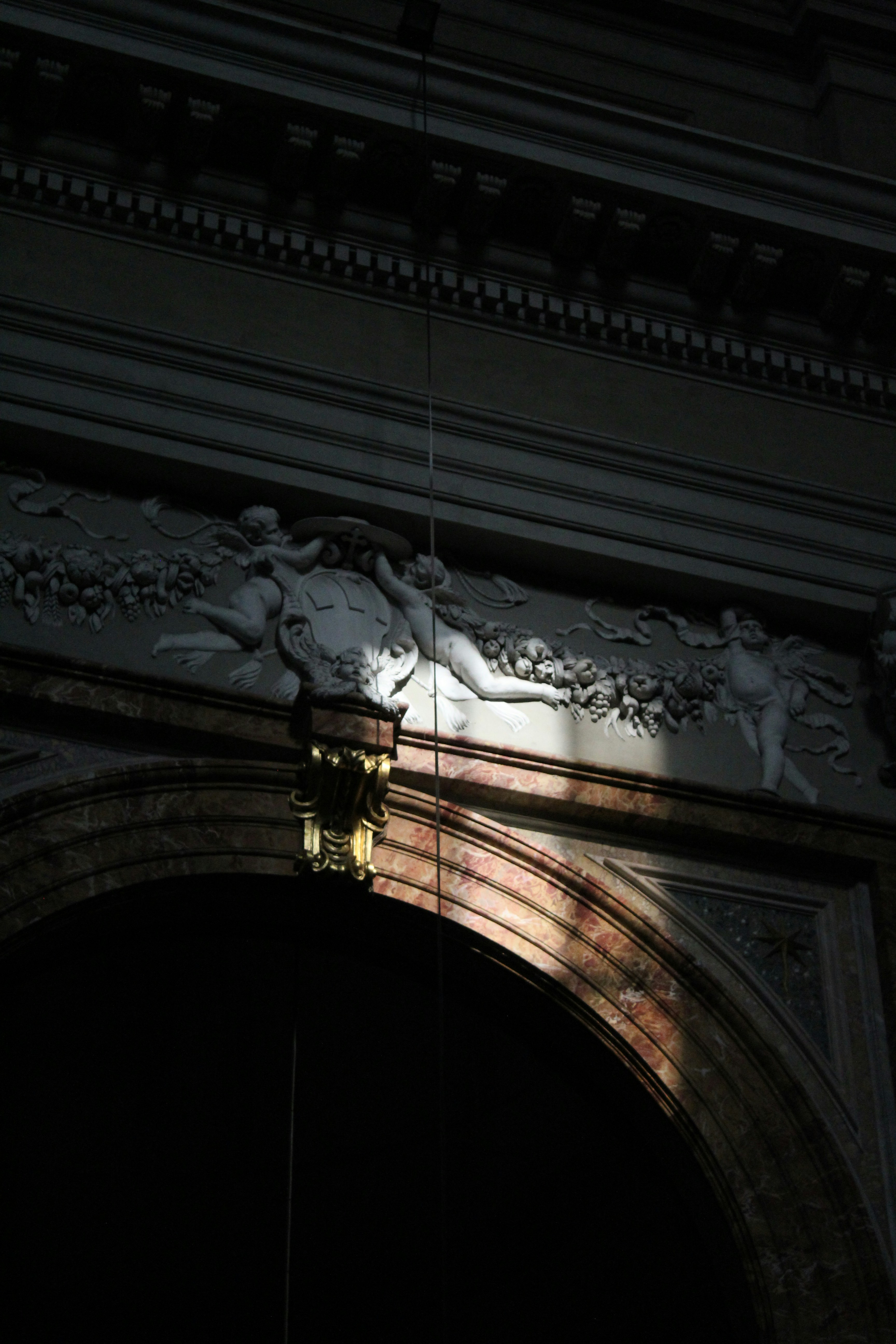 A Shaded Archway: Sculpted Reliefs and Subtle Spotlight