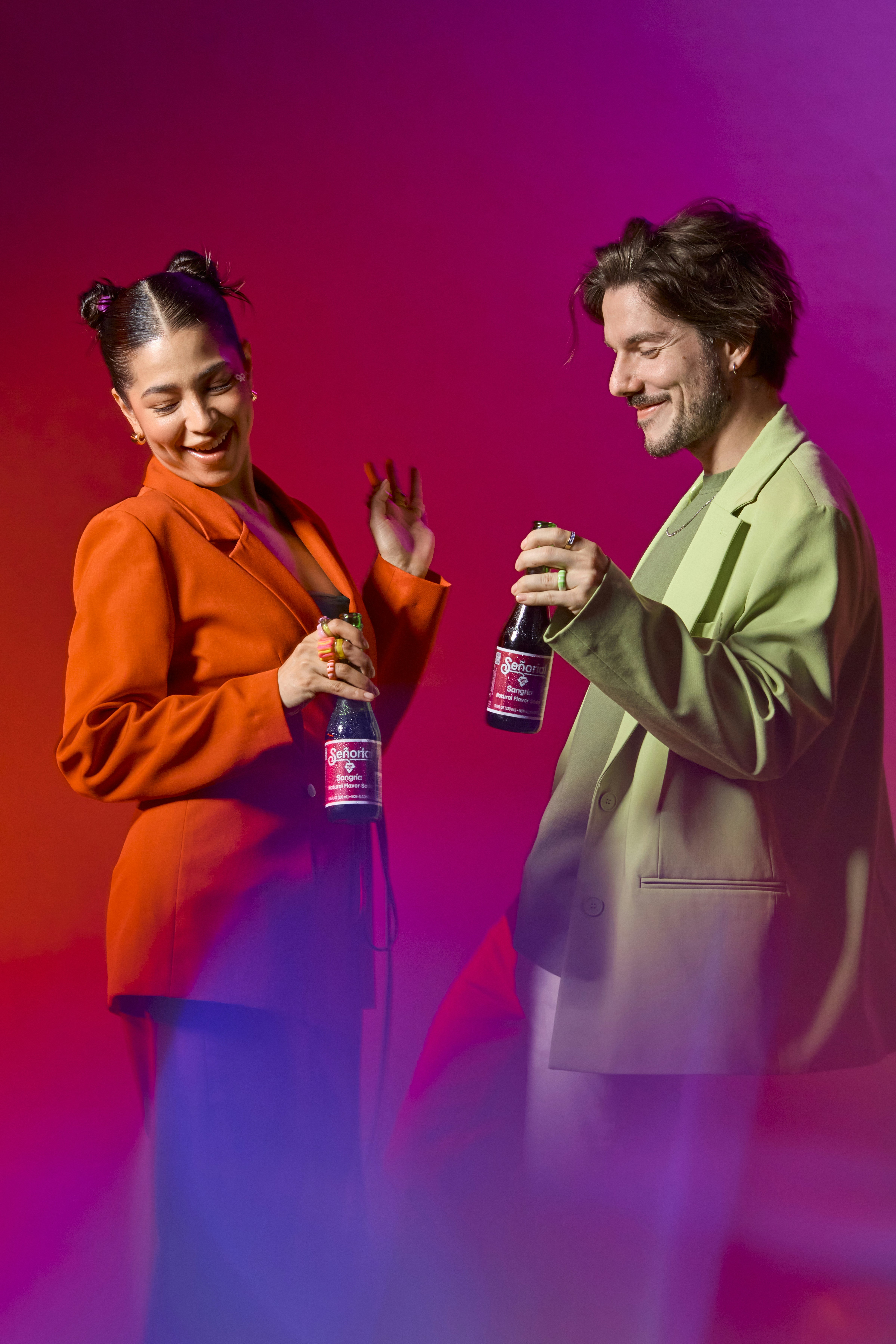 Vibrant Duo Toasting Under Neon Velvet Light