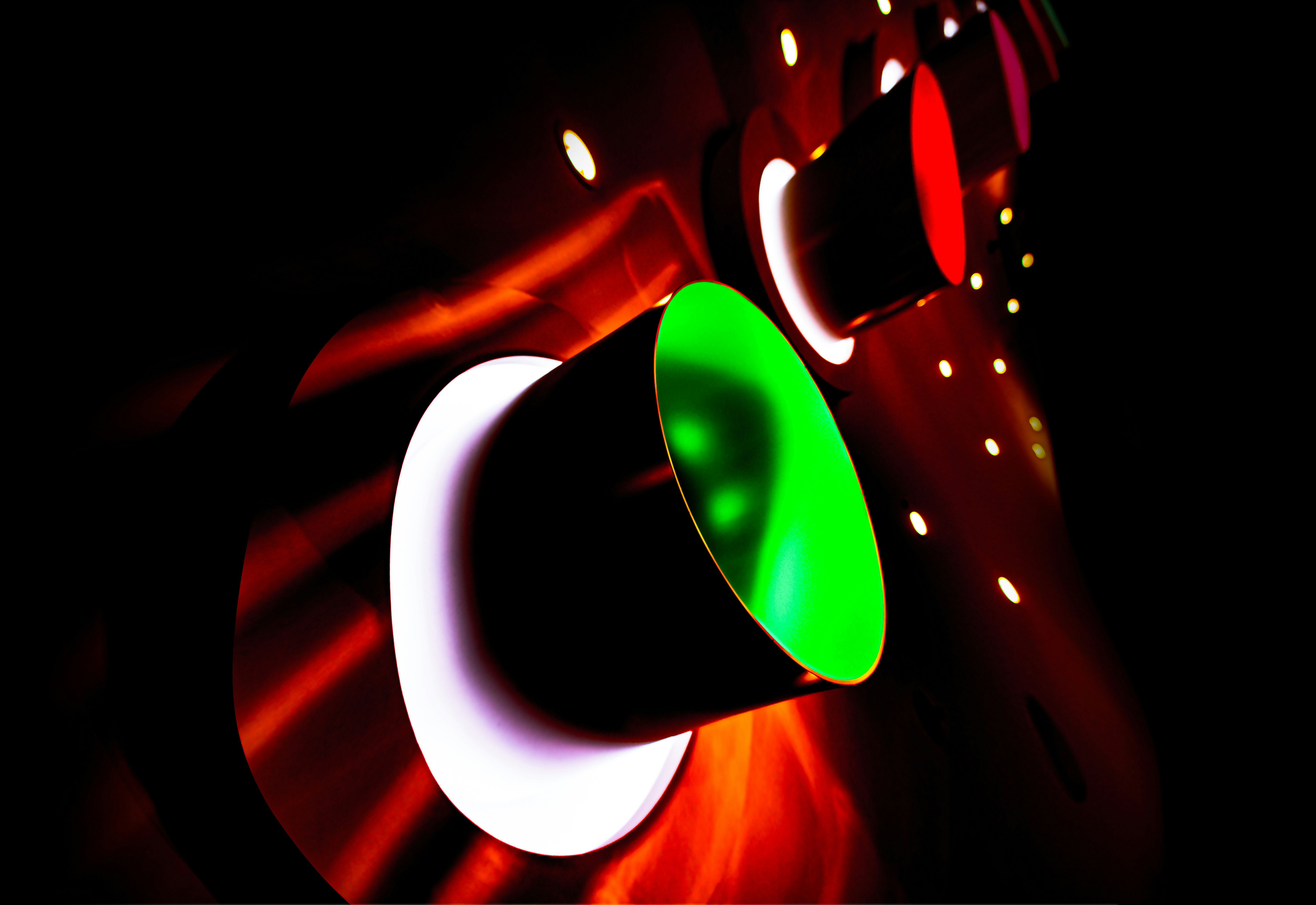 Colorful illuminated shapes glow against a dark background. photo ...