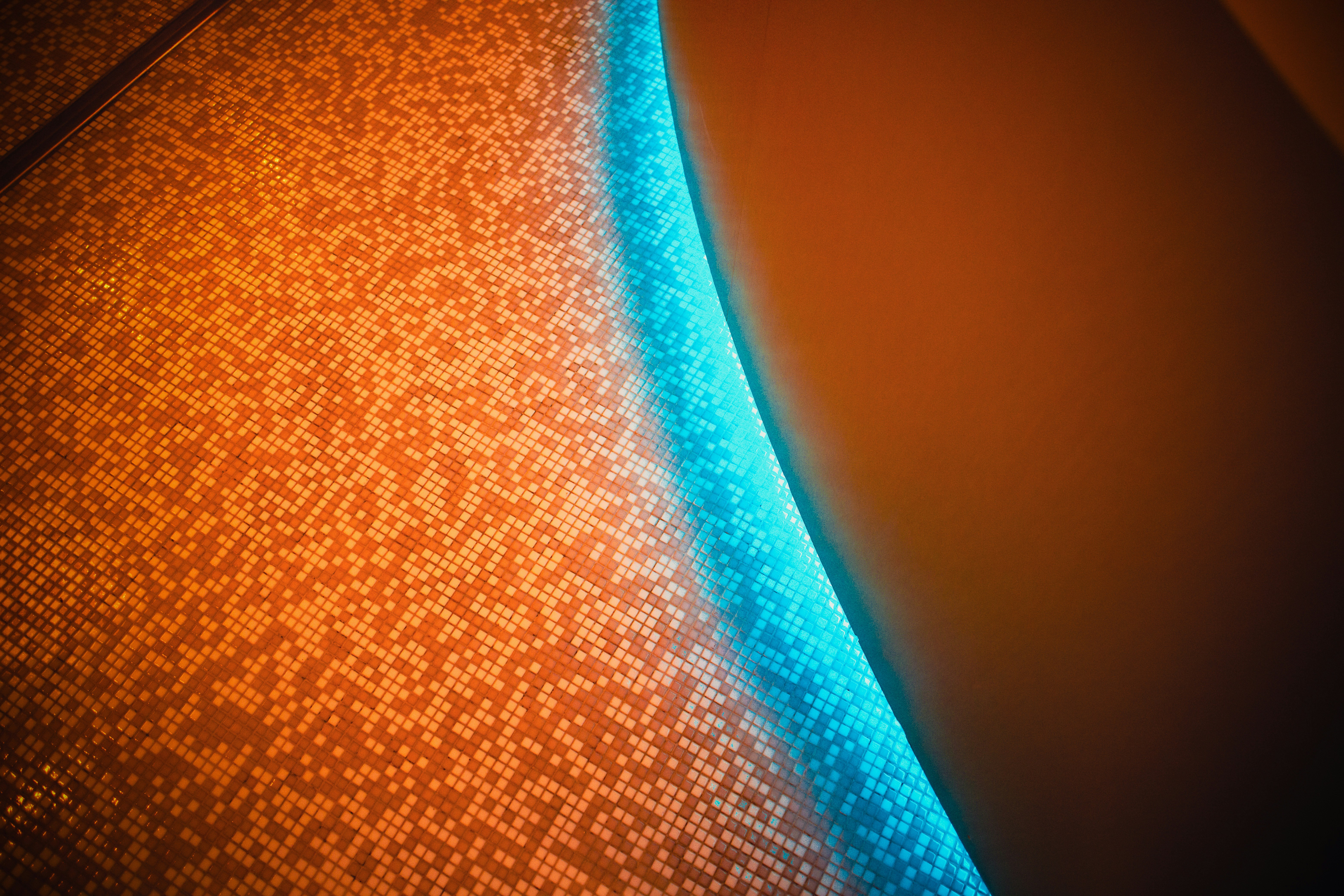 Cyan Arc Dividing a Copper Mosaic: A Macro Duotone Study