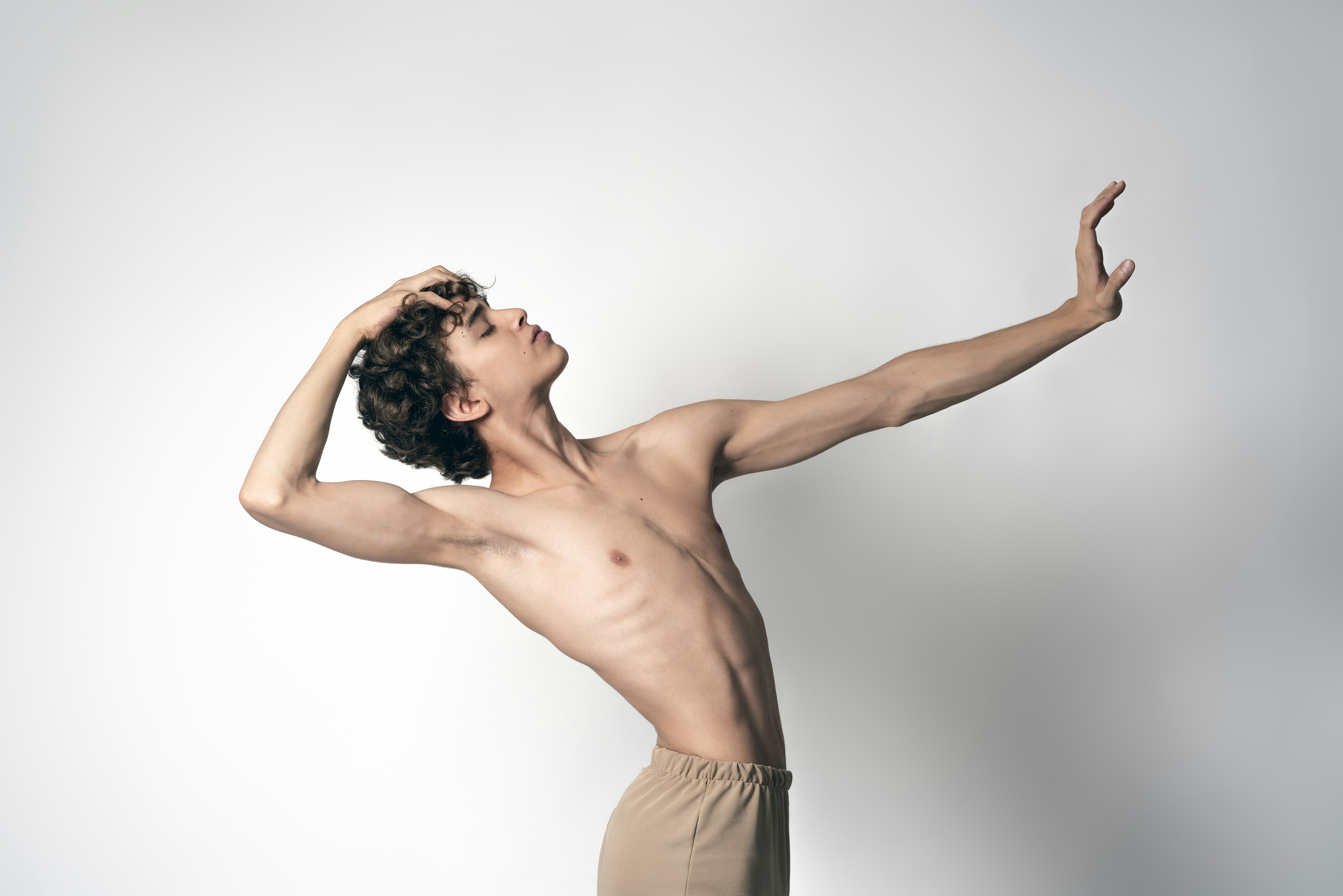 Arcing Solace: A Dancer Reaches Toward Light