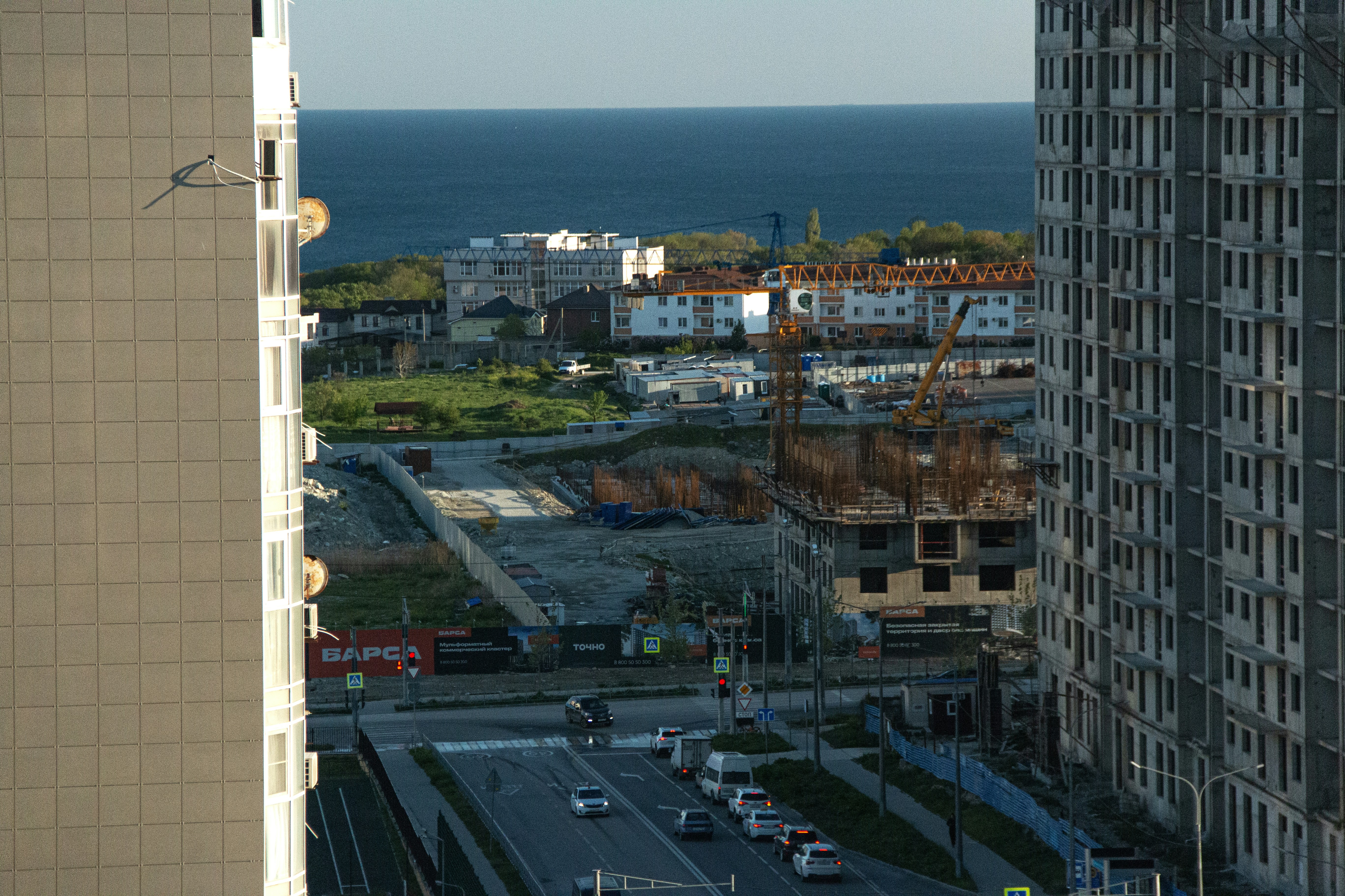 Crane Arc Over a City at the Sea's Edge