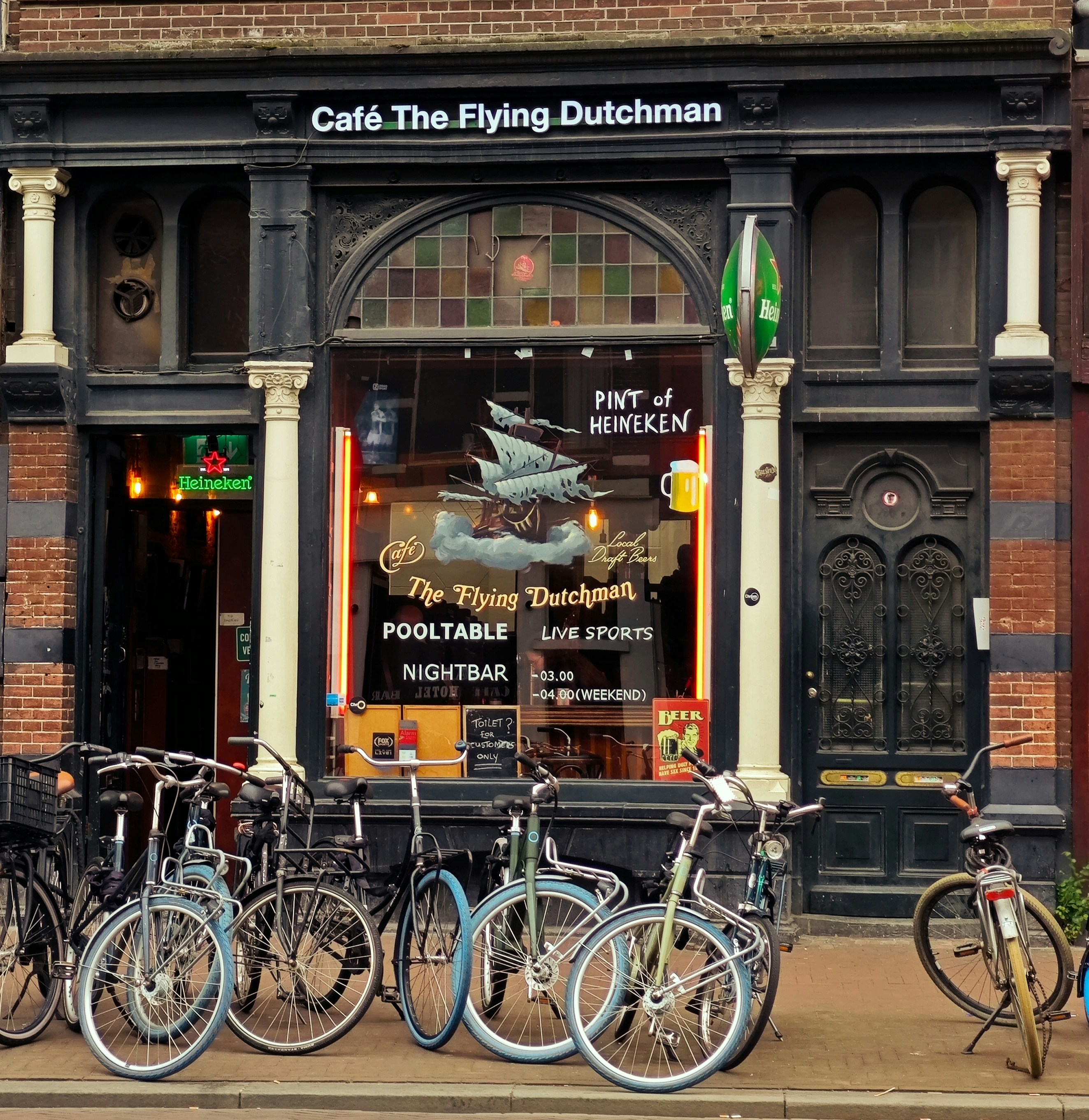 A cafe with bicycles parked out front.