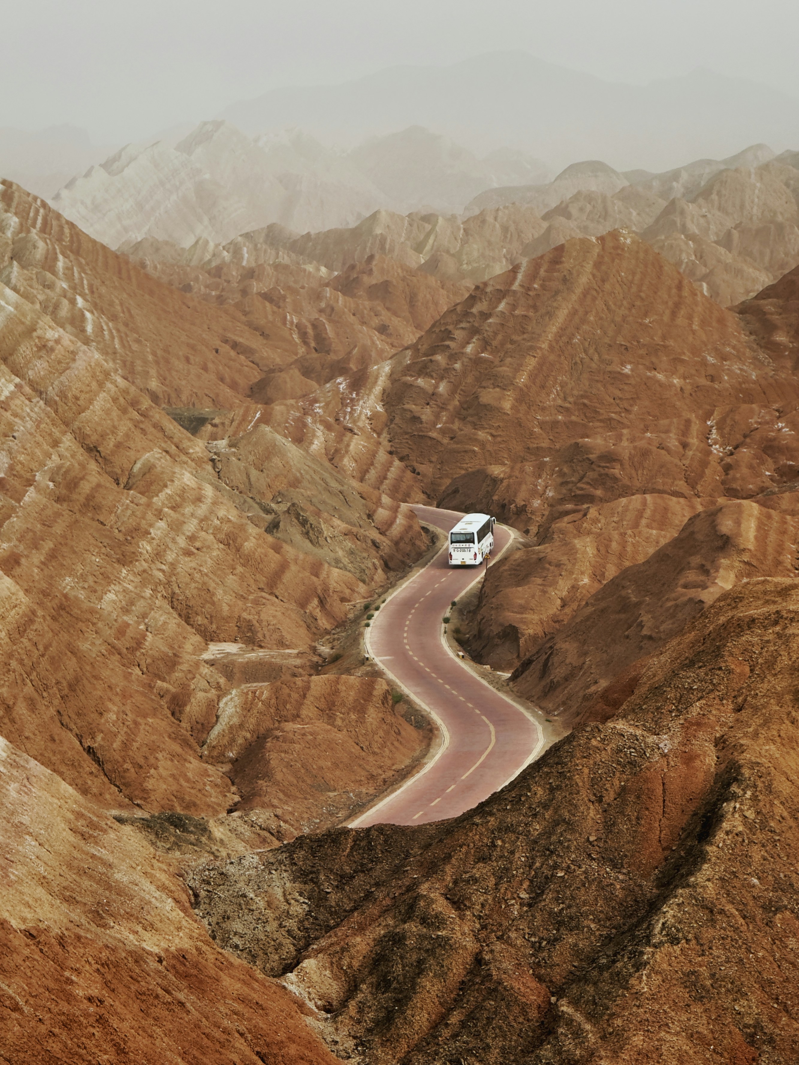 A tourist bus run through Danxia landform in Zhangye, Gansu, China.