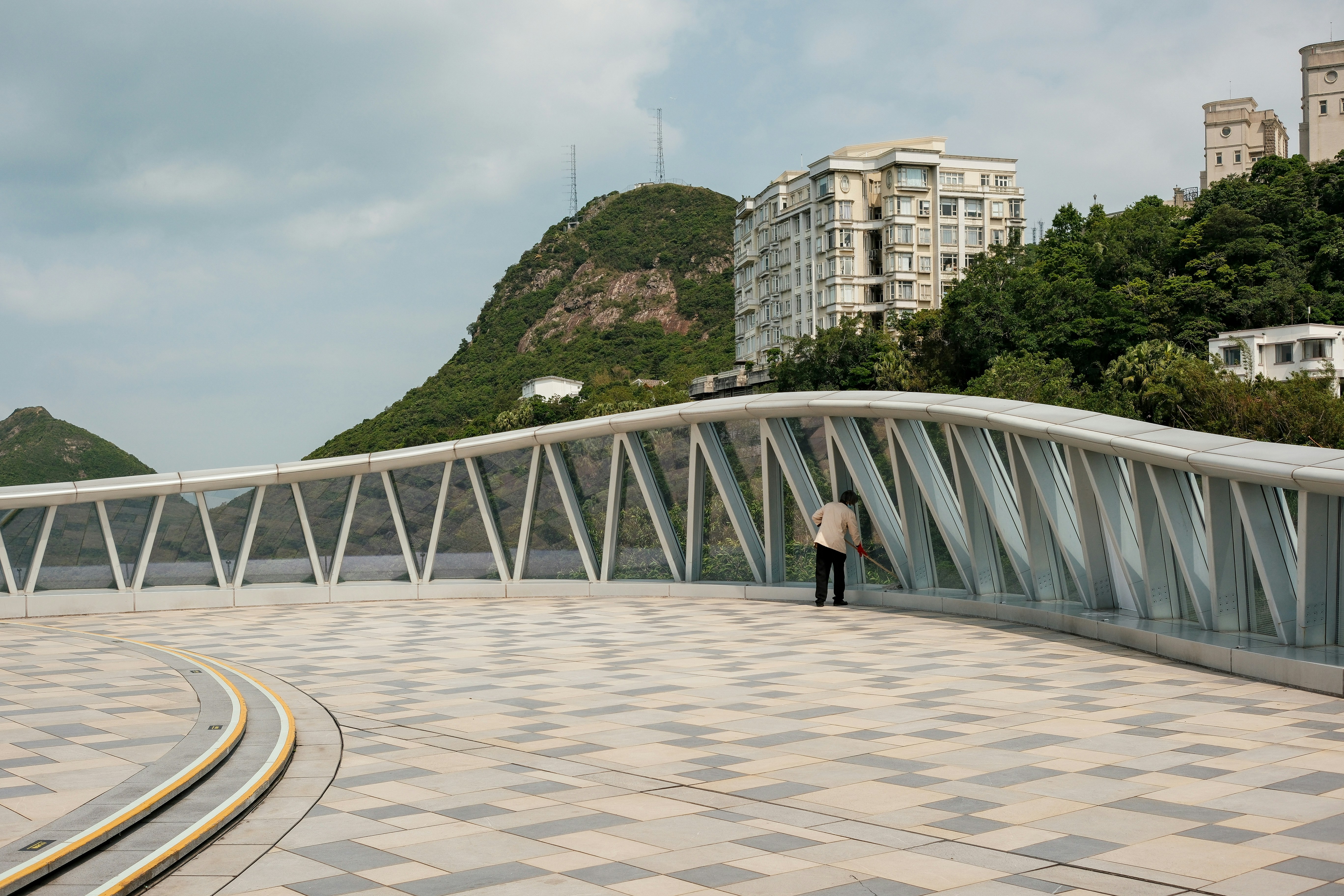A person looks over a curved bridge railing. photo – Free Wallpaper ...