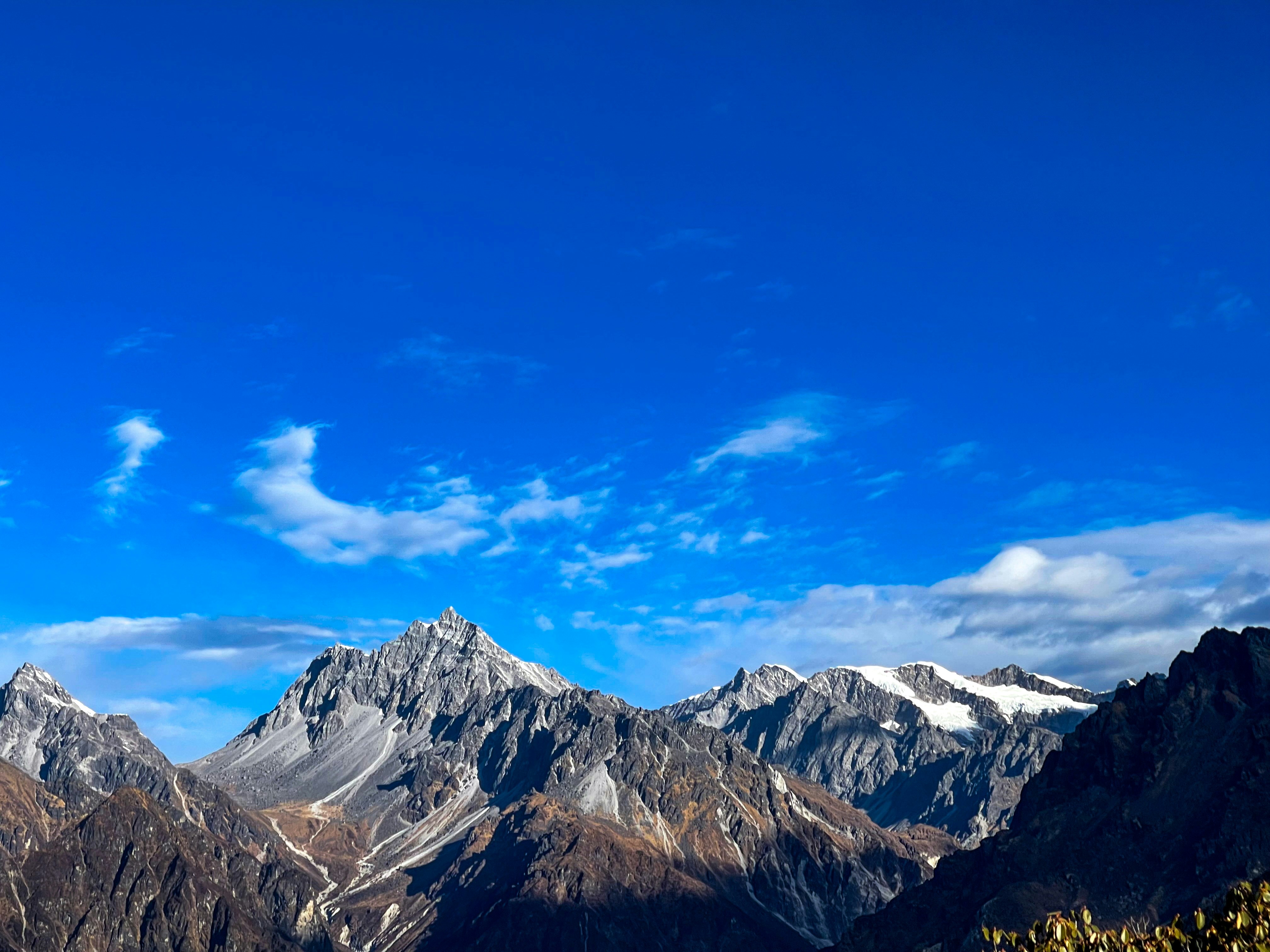 This a view from a Ama Yangri which is famous for short trekking destination this is a helambu Circuit trekking which is one of the famous destinations for the travellers | Mountains rise under a brilliant blue sky.