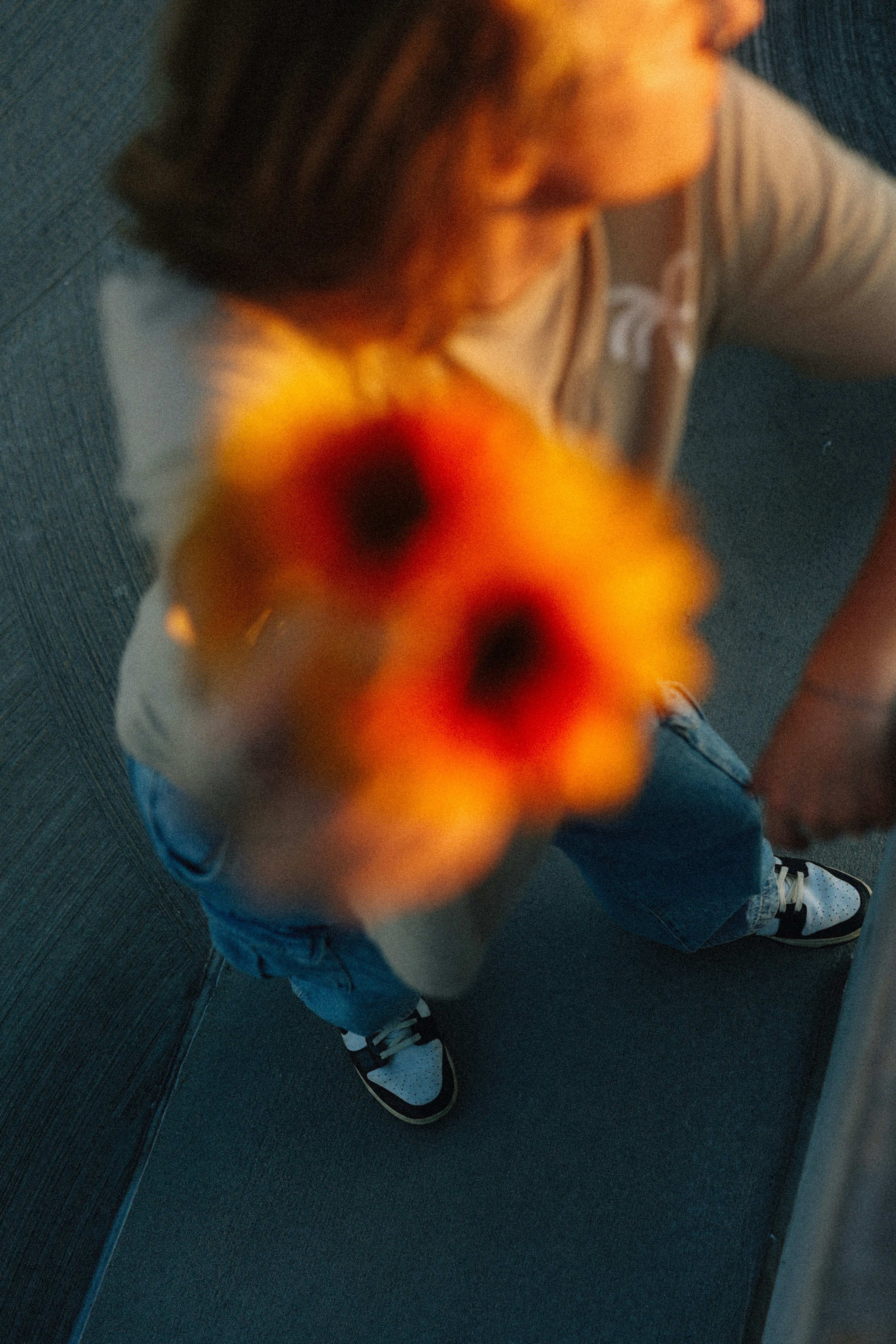 Blurry Bouquet in Hand: An Up-Close Moment on a Stairwell