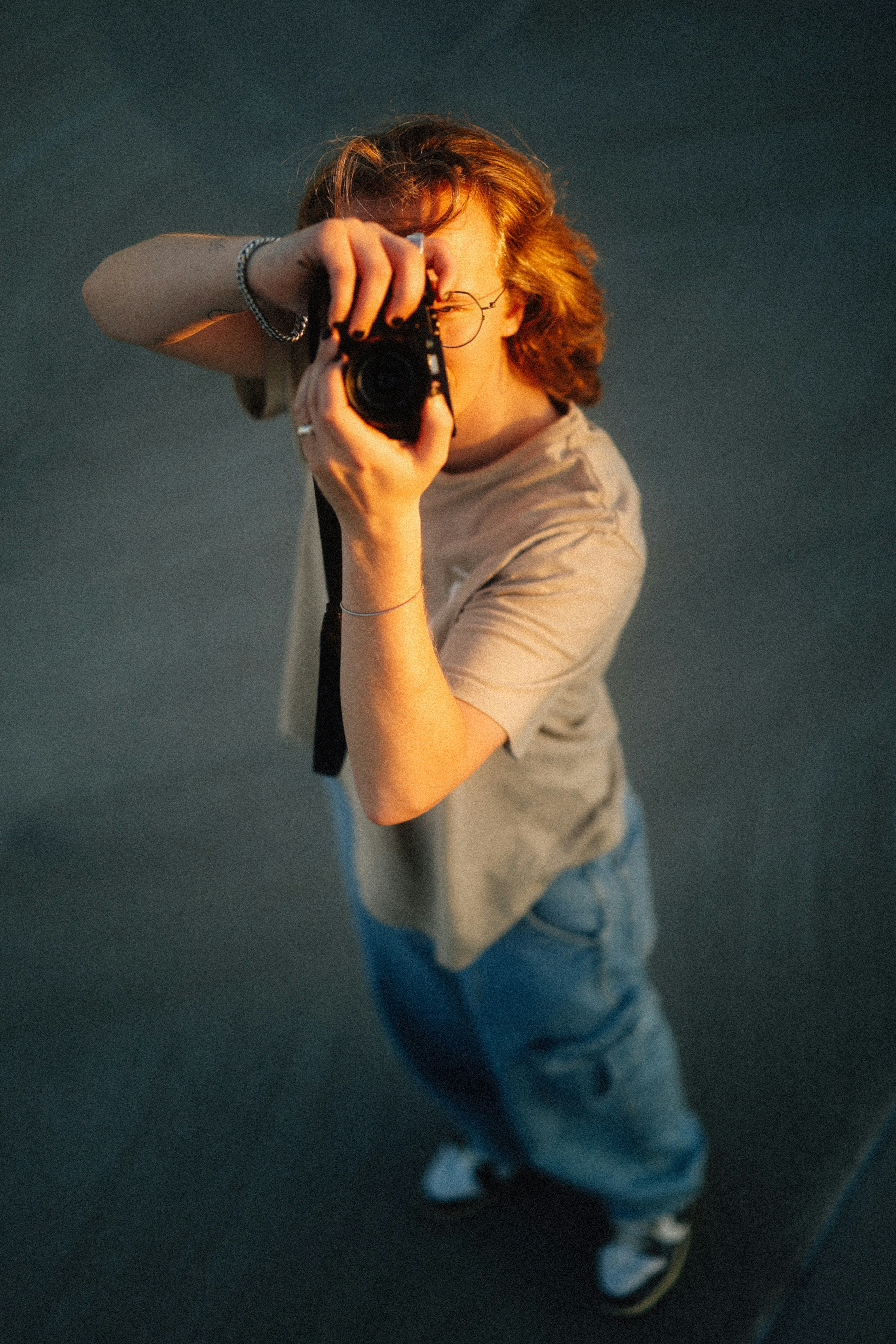 Tilted Gaze: A Photographer Framing a Moment from a High Vantage