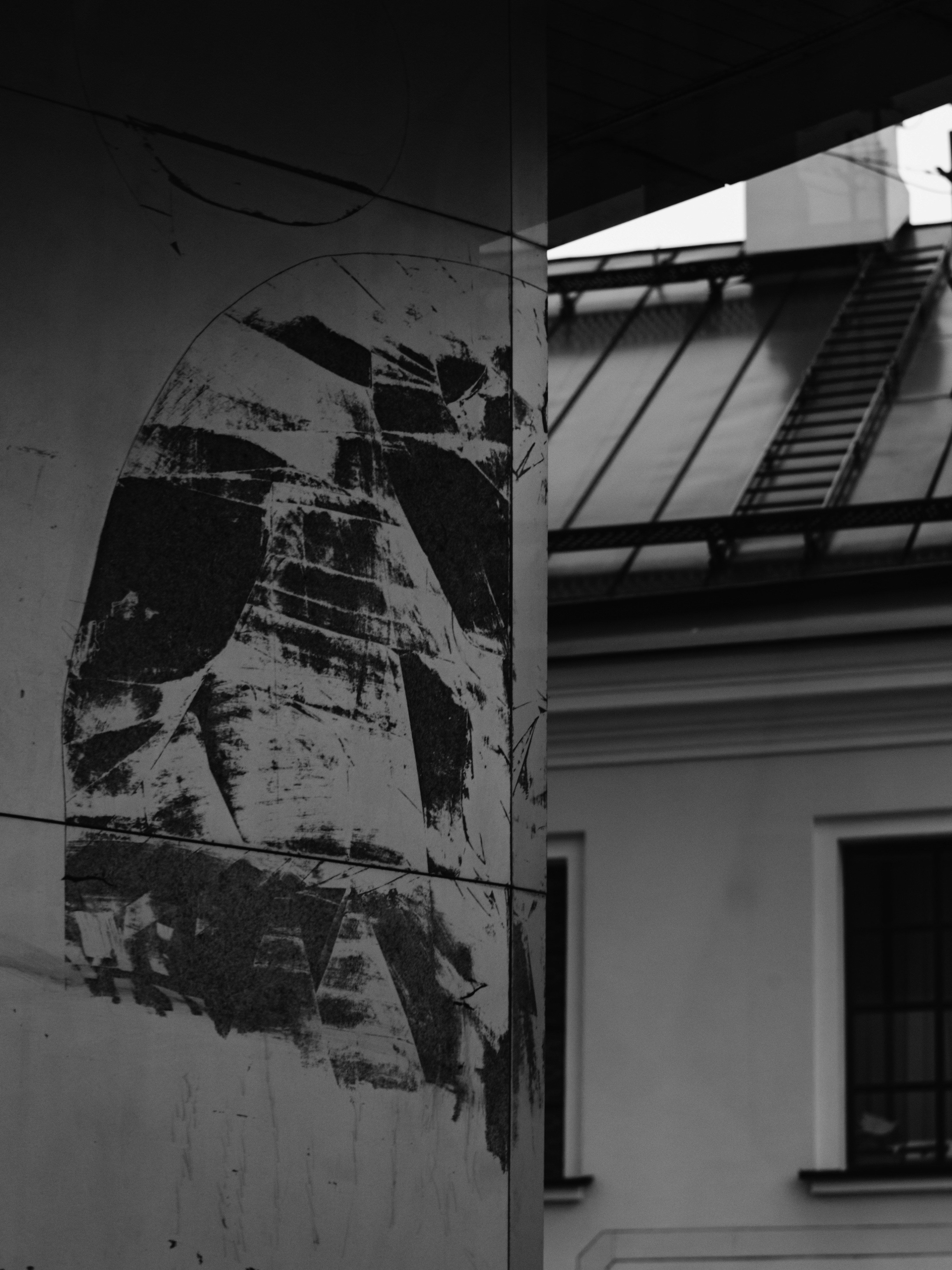 Weathered Pillar Between Concrete and Glass