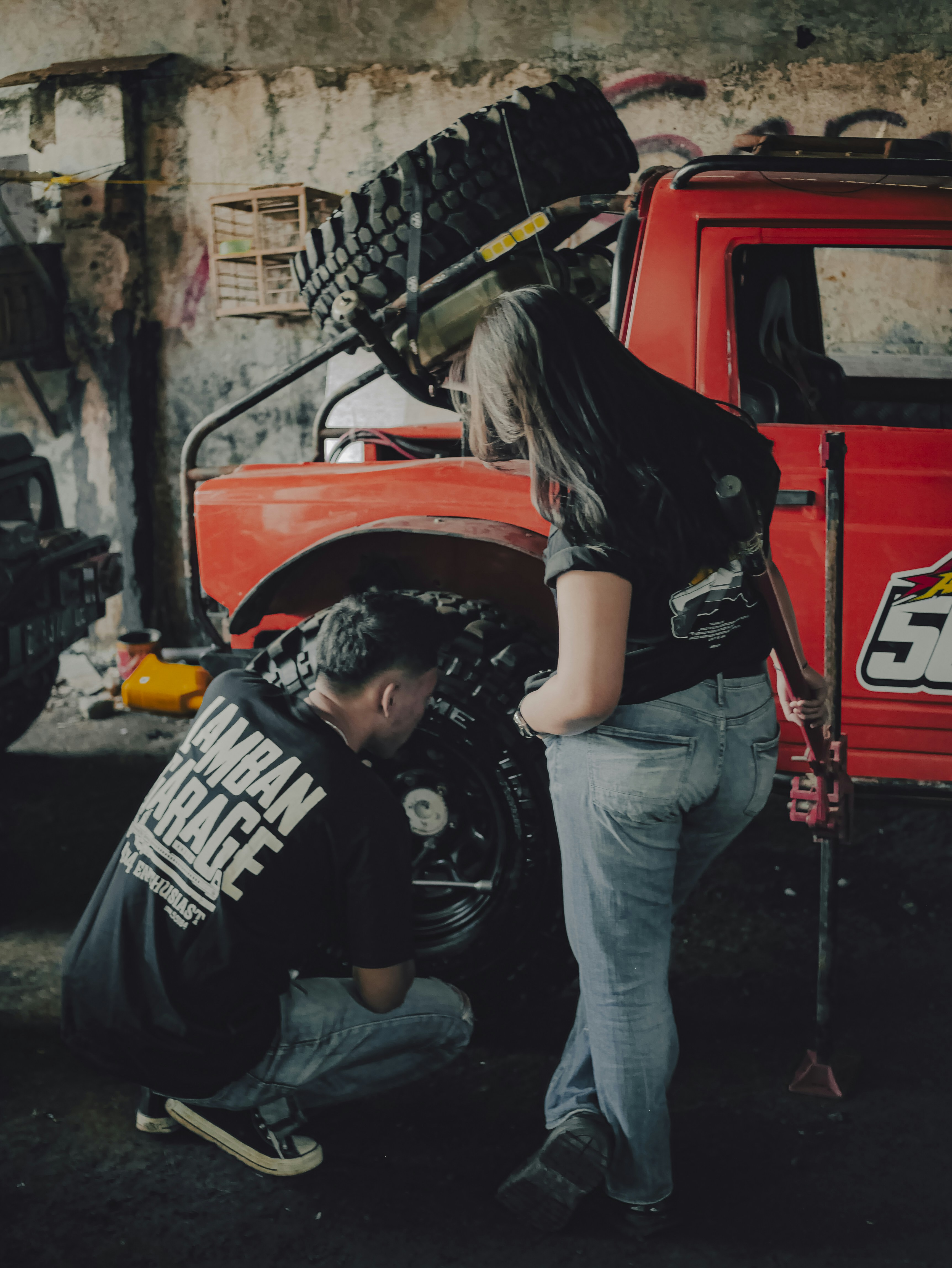 Two Mechanics in a Red Pickup: Tire, Tools, and Teamwork