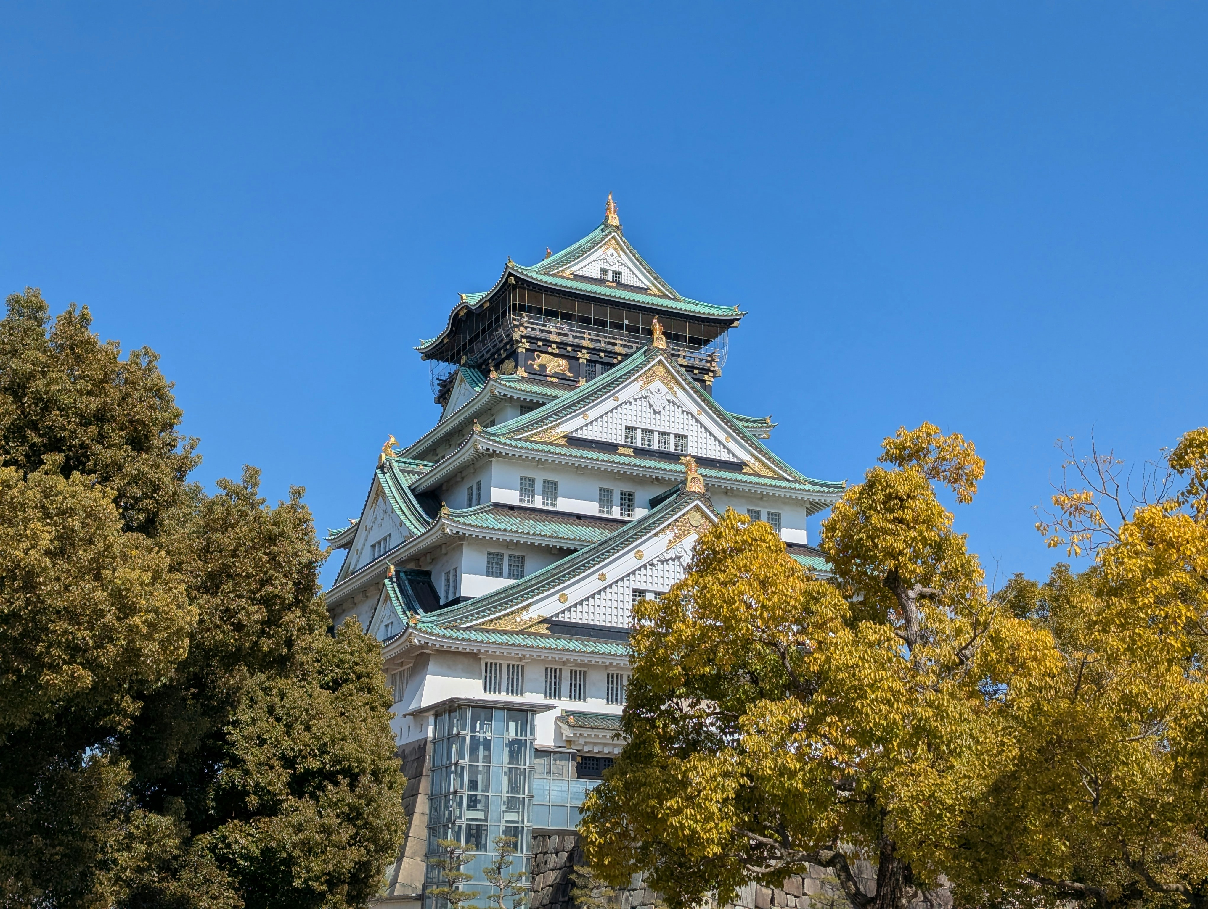 Osaka Castle in Autumn: Emerald Roofs Against a Crisp Blue Sky