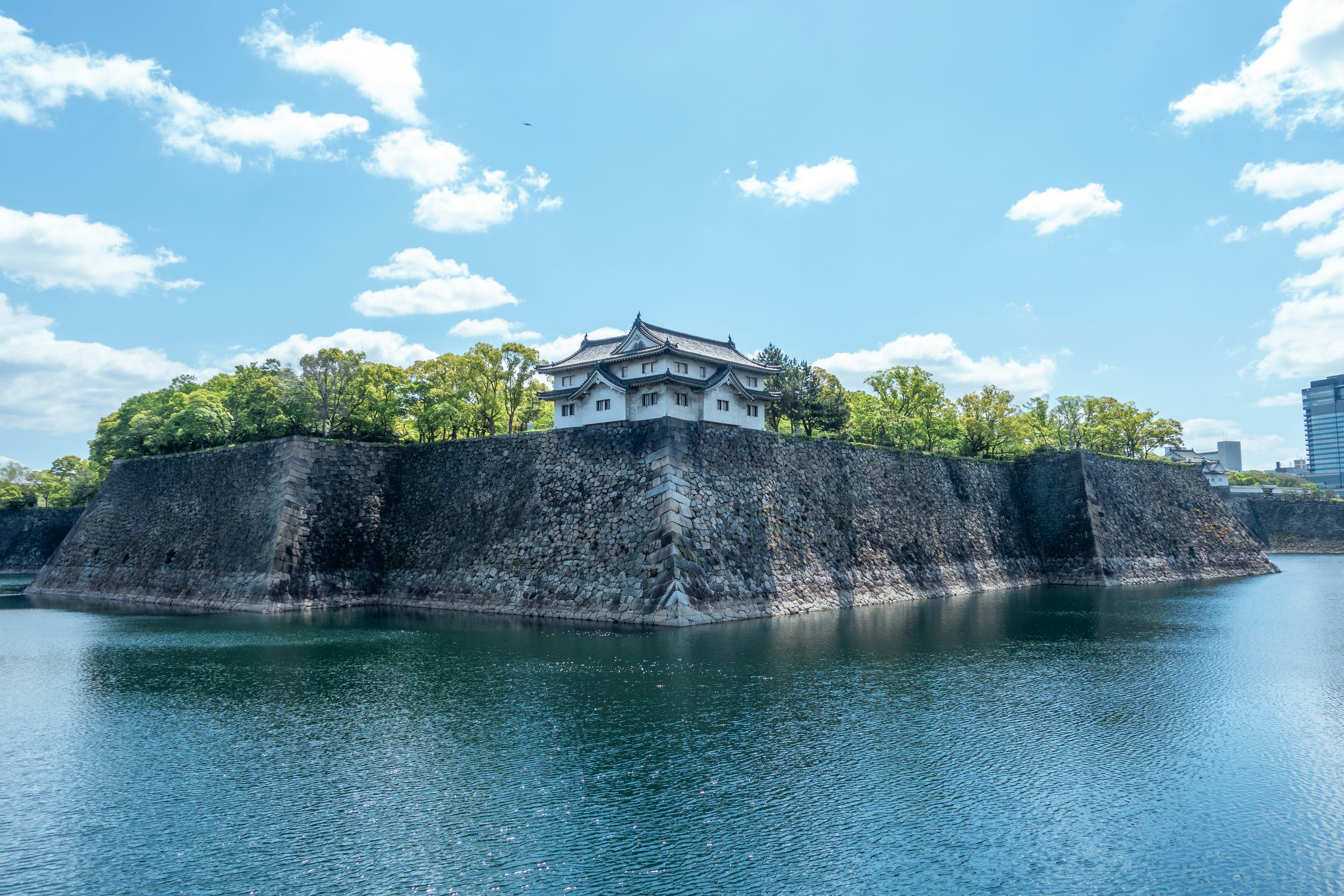 A majestic castle rises above the water. photo – Free Osaka castle ...