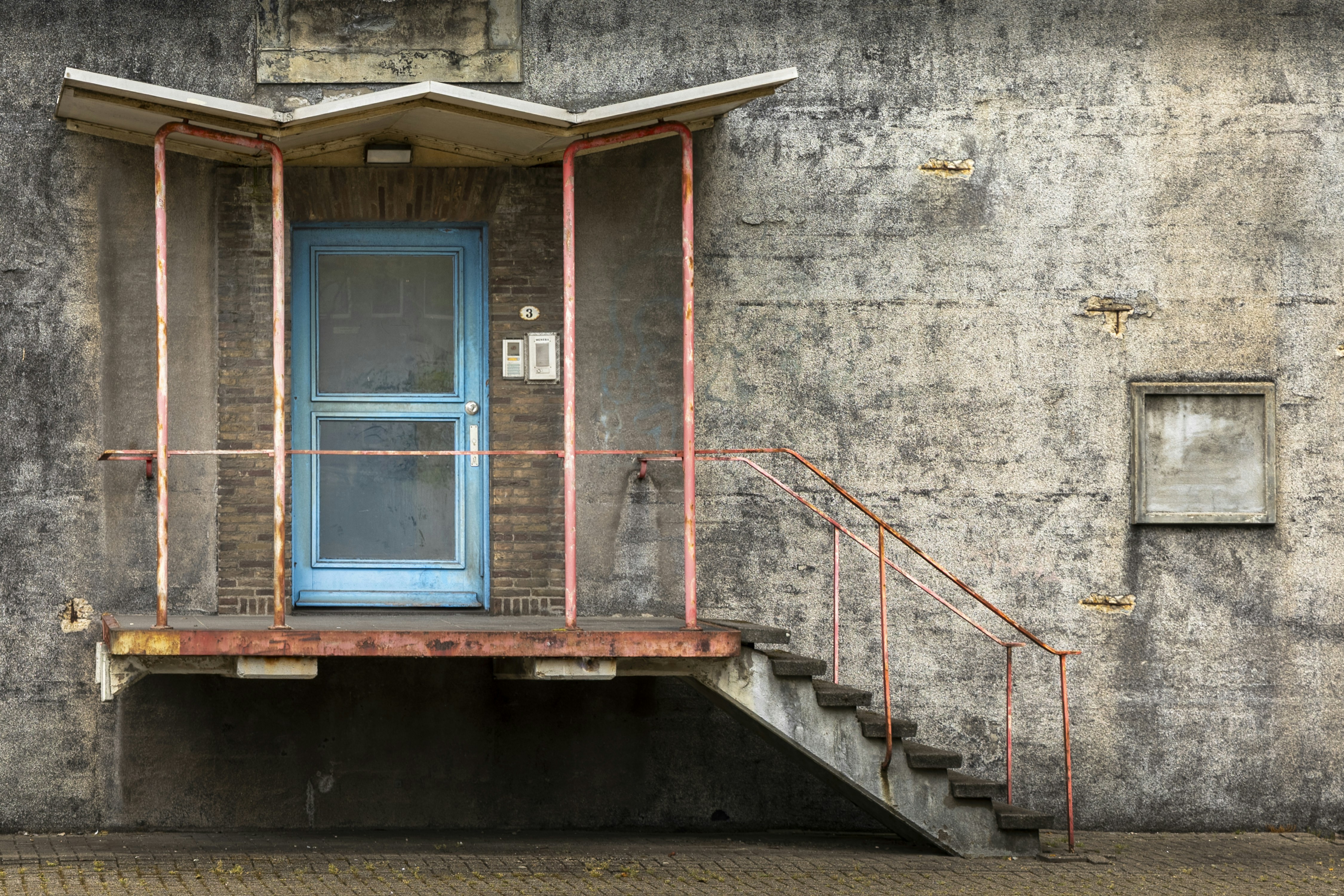 Blue Door on a Deteriorating Balcony