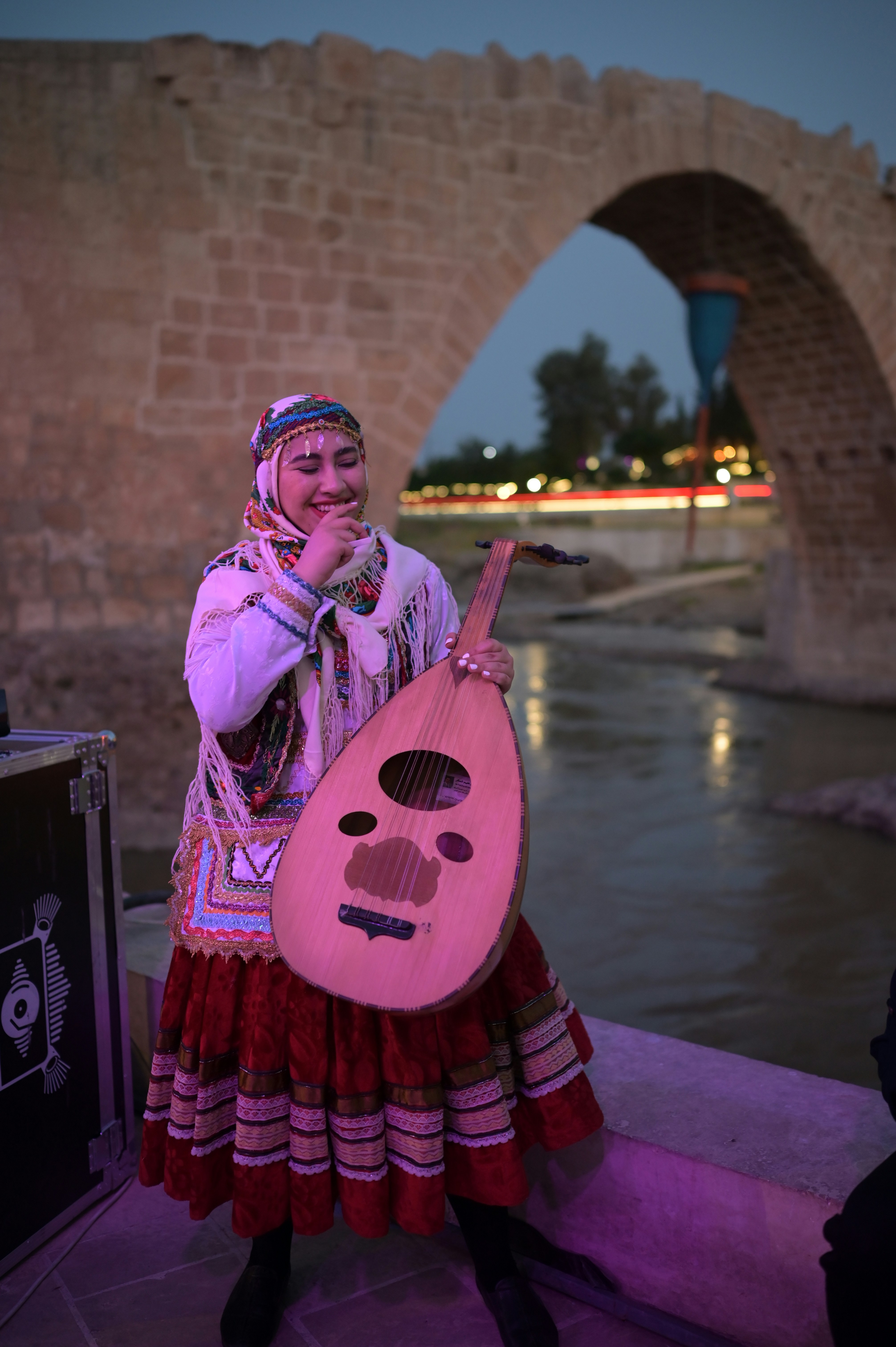 Dusk Serenade by the Stone Arch: Oud Player at River's Edge
