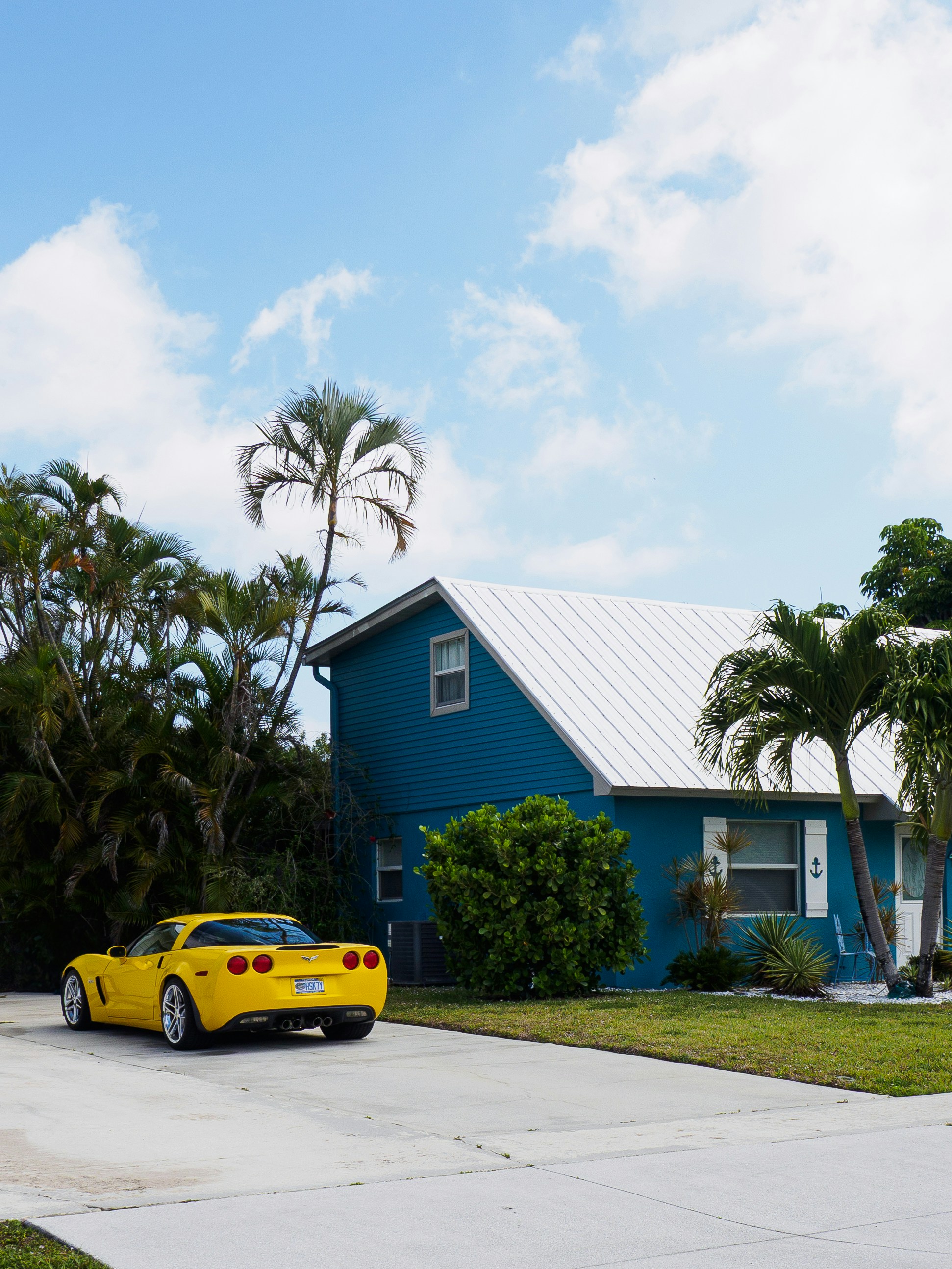 Yellow Dream Car in a Coastal Blue Cottage Driveway