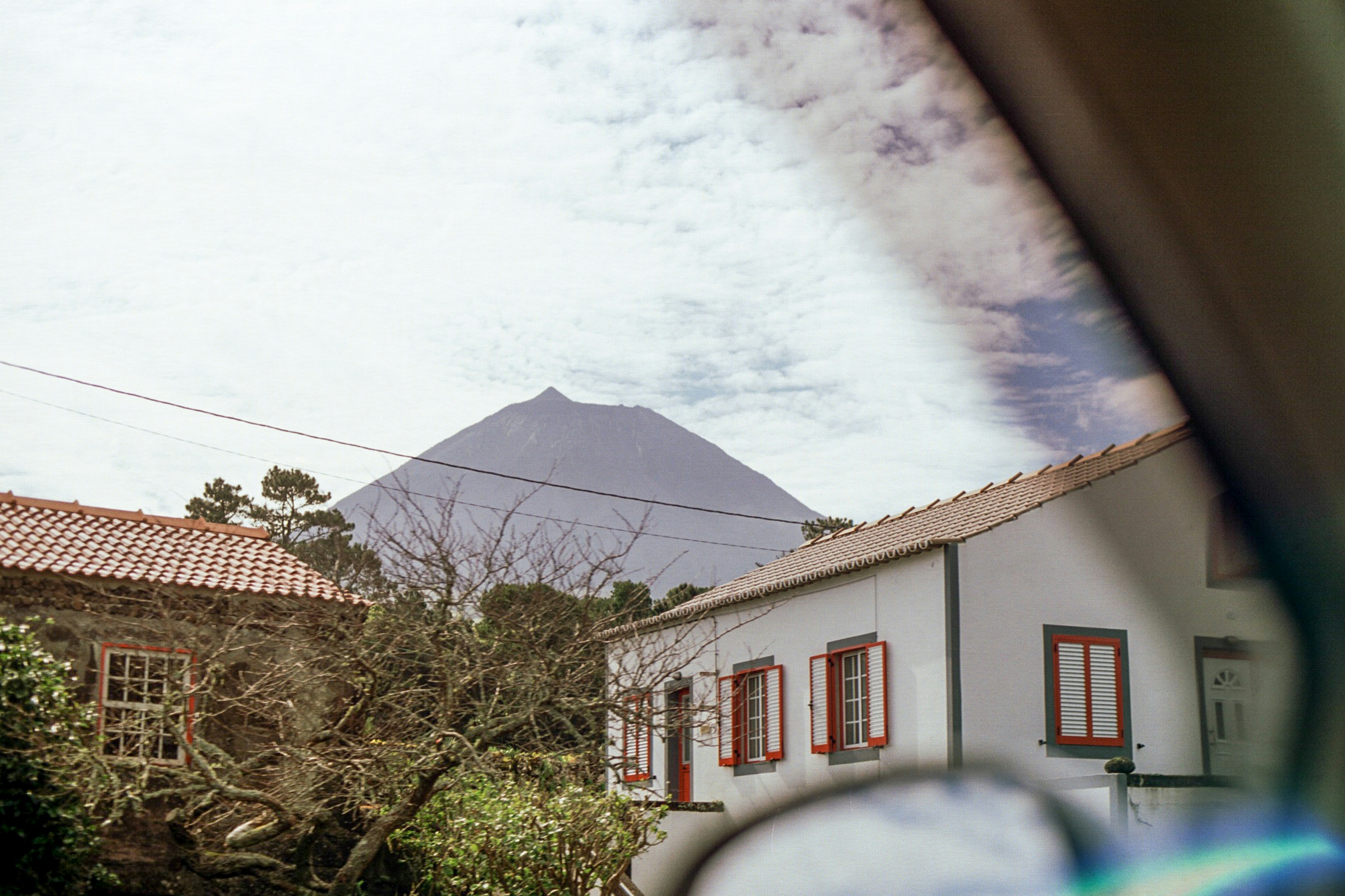 Peak Over Tile Roofs: Distant Summit Framed by Quiet Suburban Lines