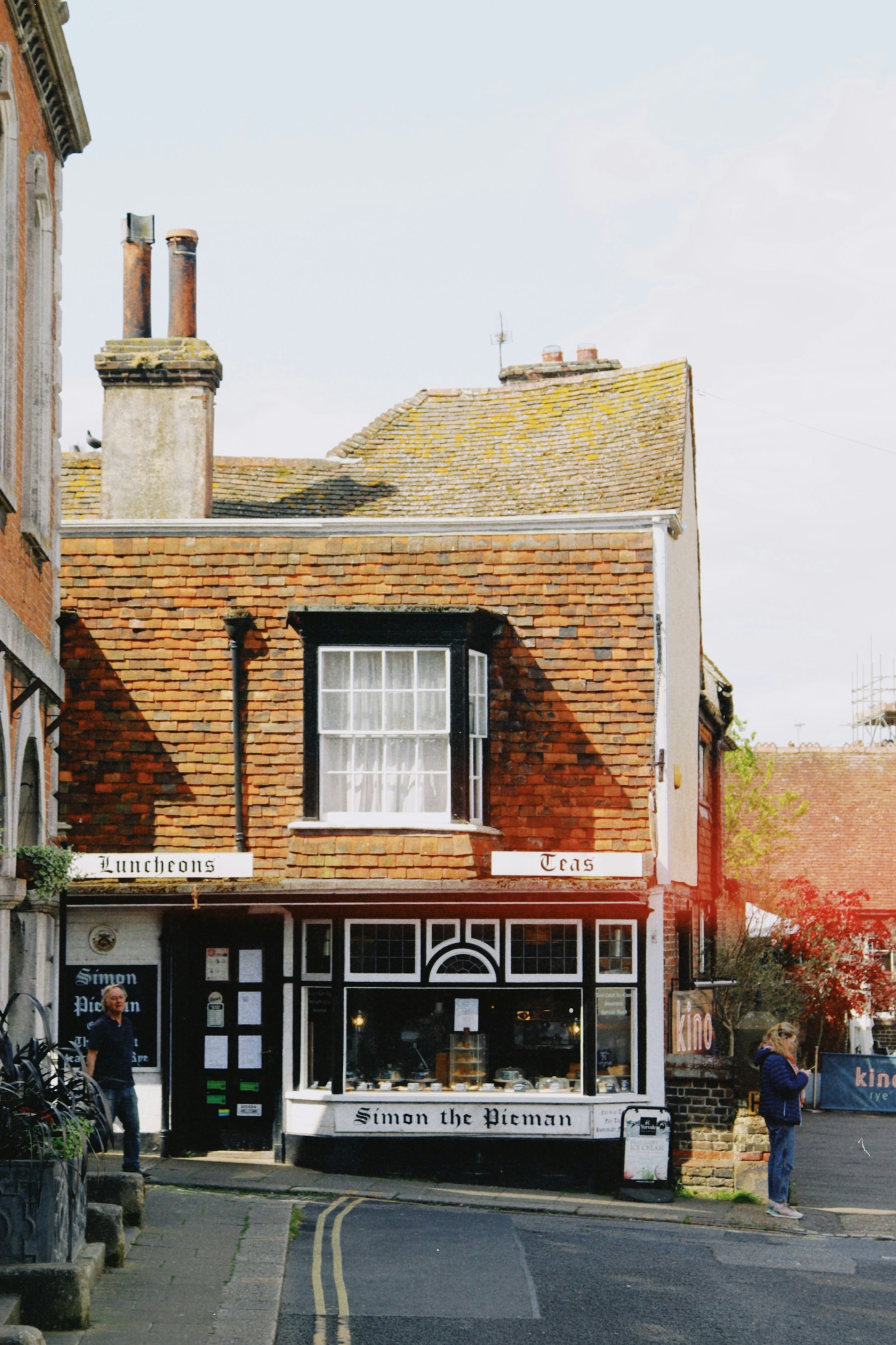 Quaint building with a shop on a slightly curved street. photo – Free ...
