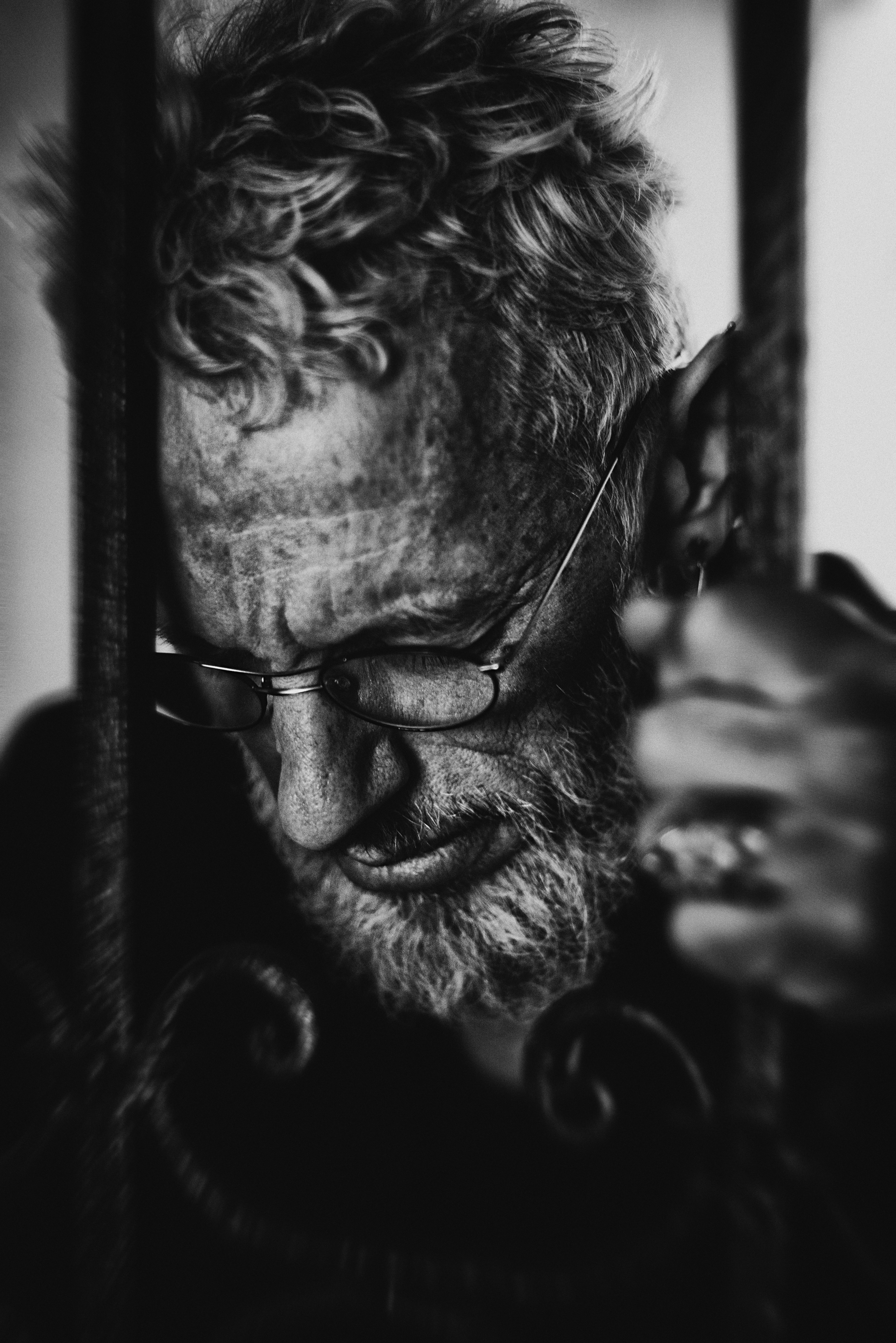 A man looks through bars, seemingly imprisoned. photo – Free Man Image ...