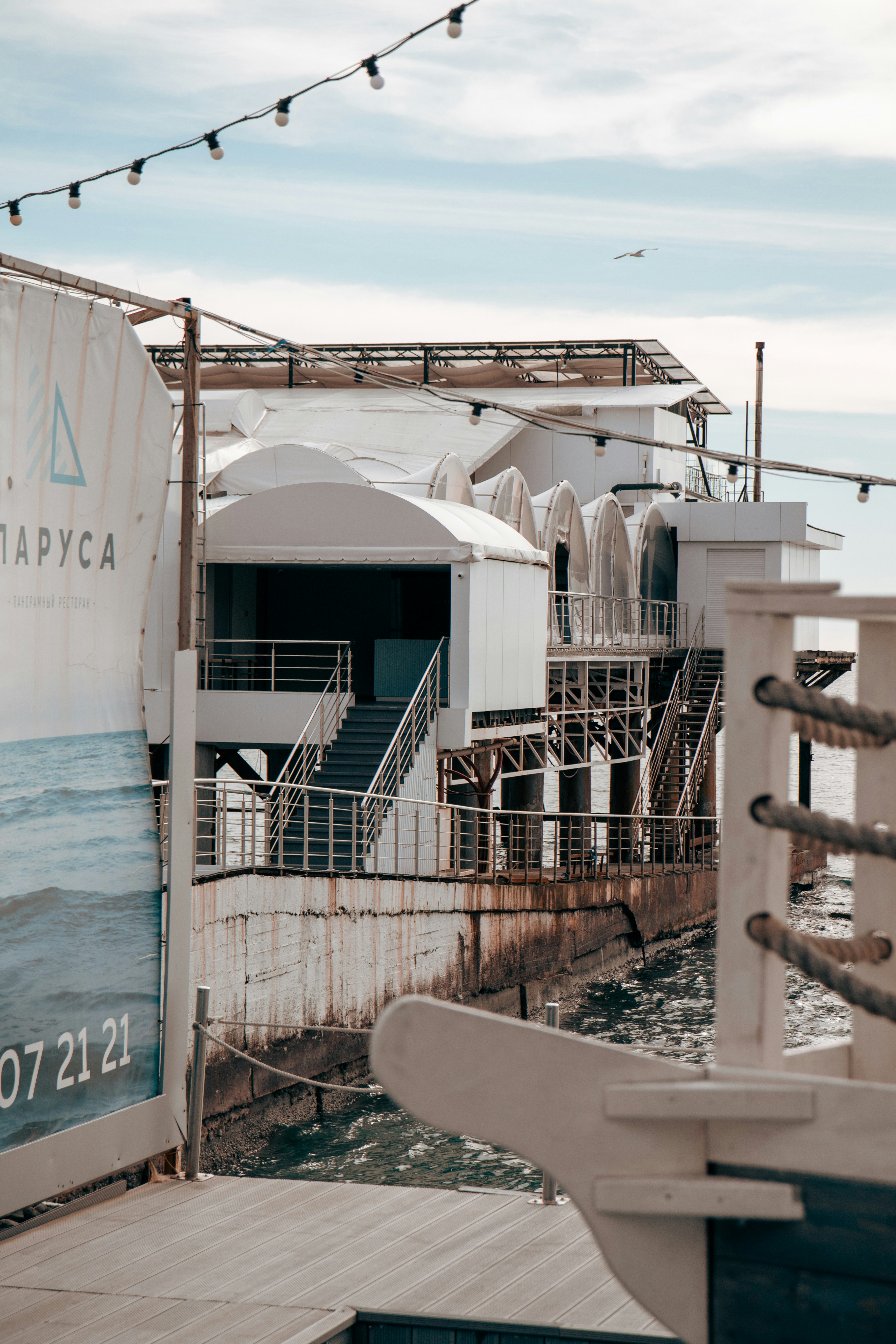 Harbor Architecture in Soft Light: White Domes, Rusted Rails, and Seagulls
