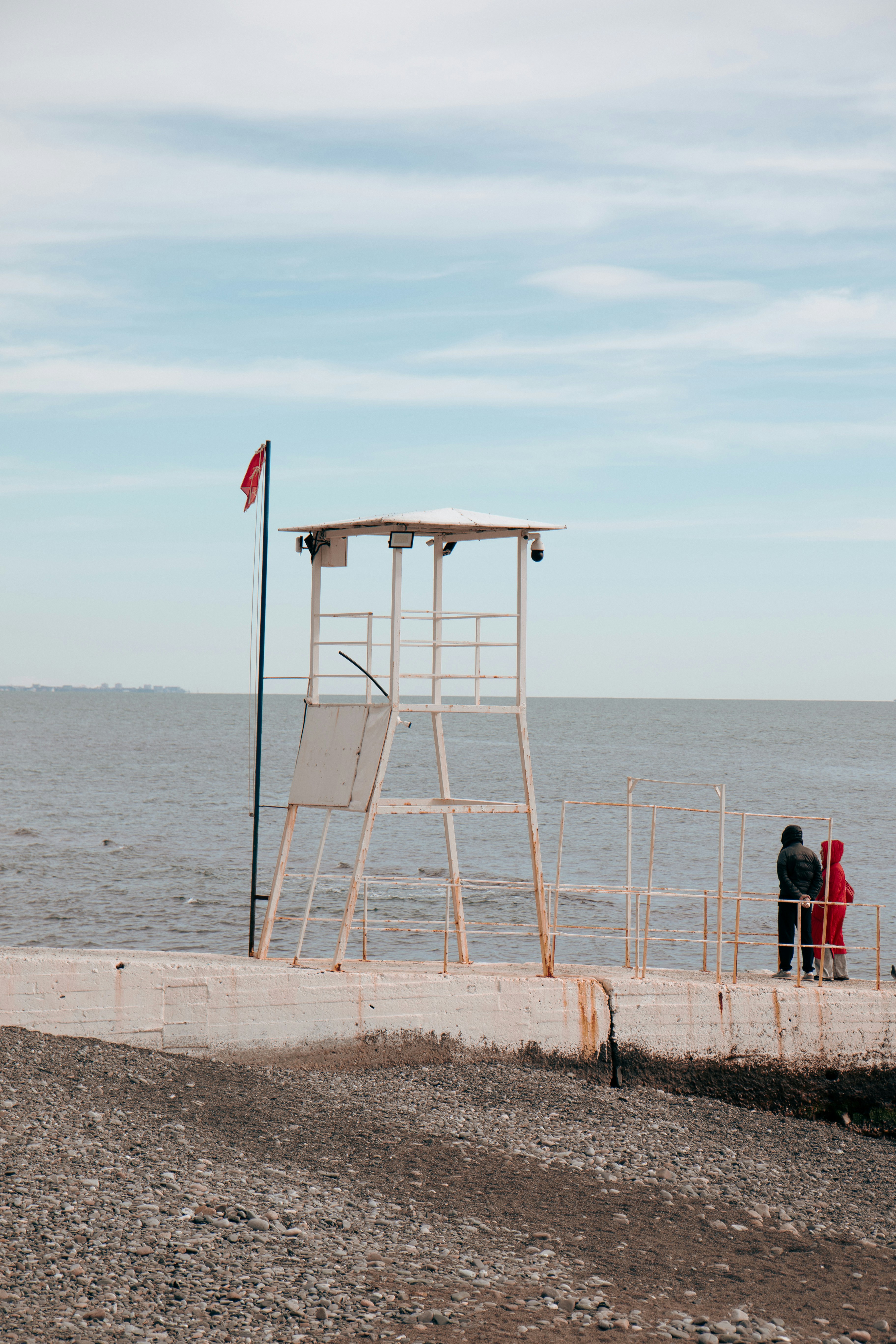 Lifeguard Post aside a quiet shoreline, watching the horizon