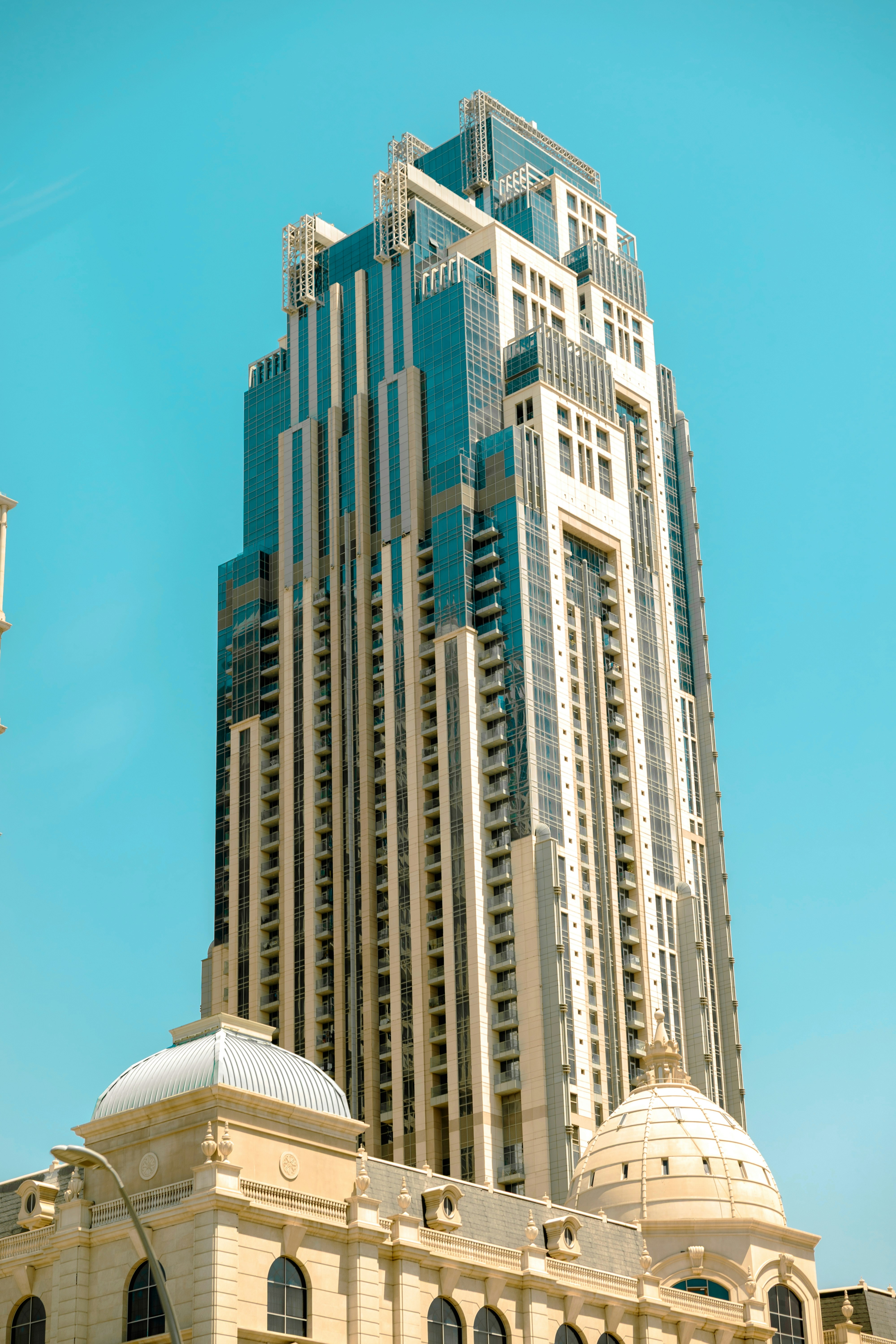 A tall modern building reaches upwards into the blue. photo – Free ...