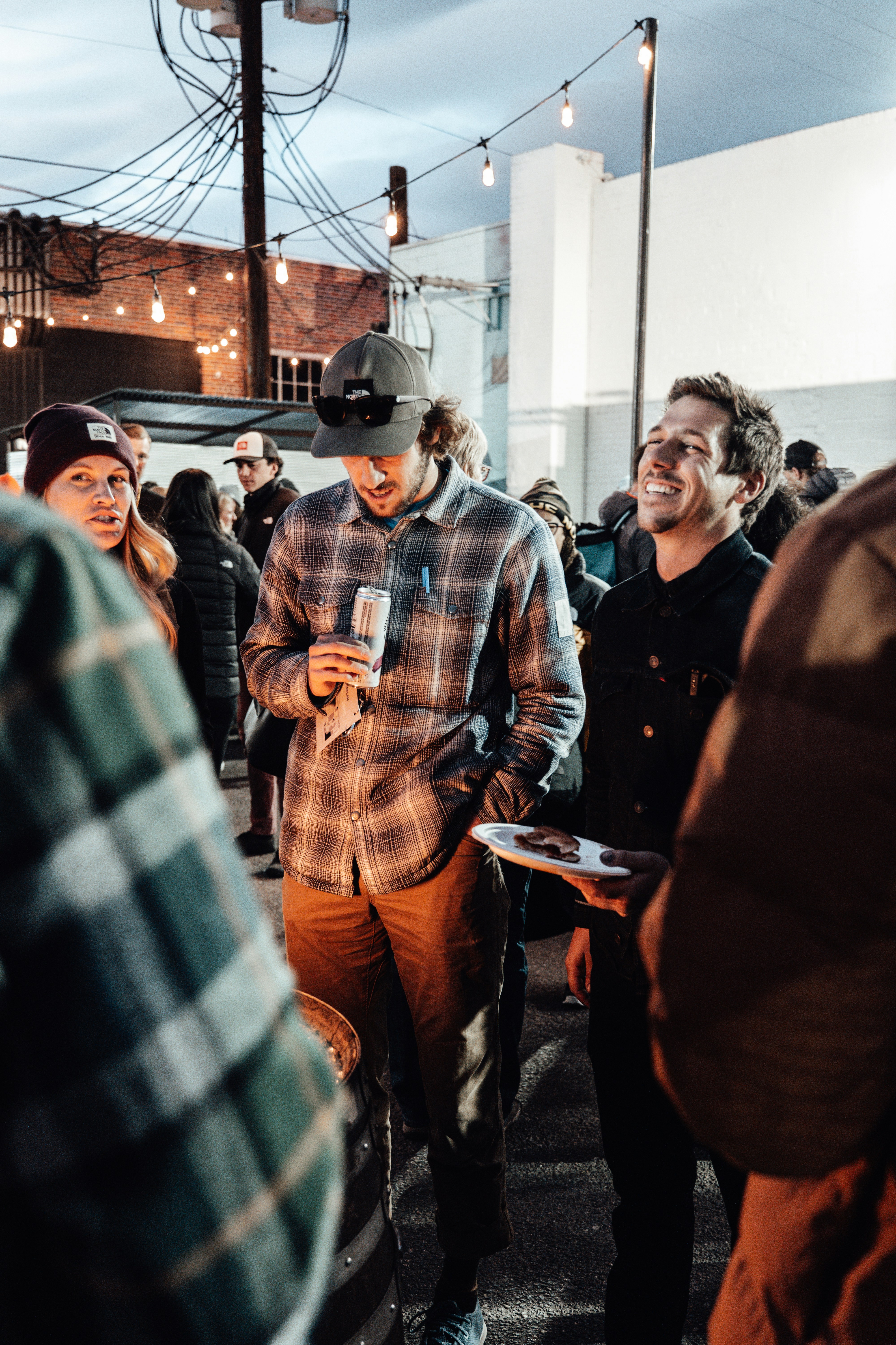 Rooftop Revelry Under Warm Glow: A Plaid-Clad Moment