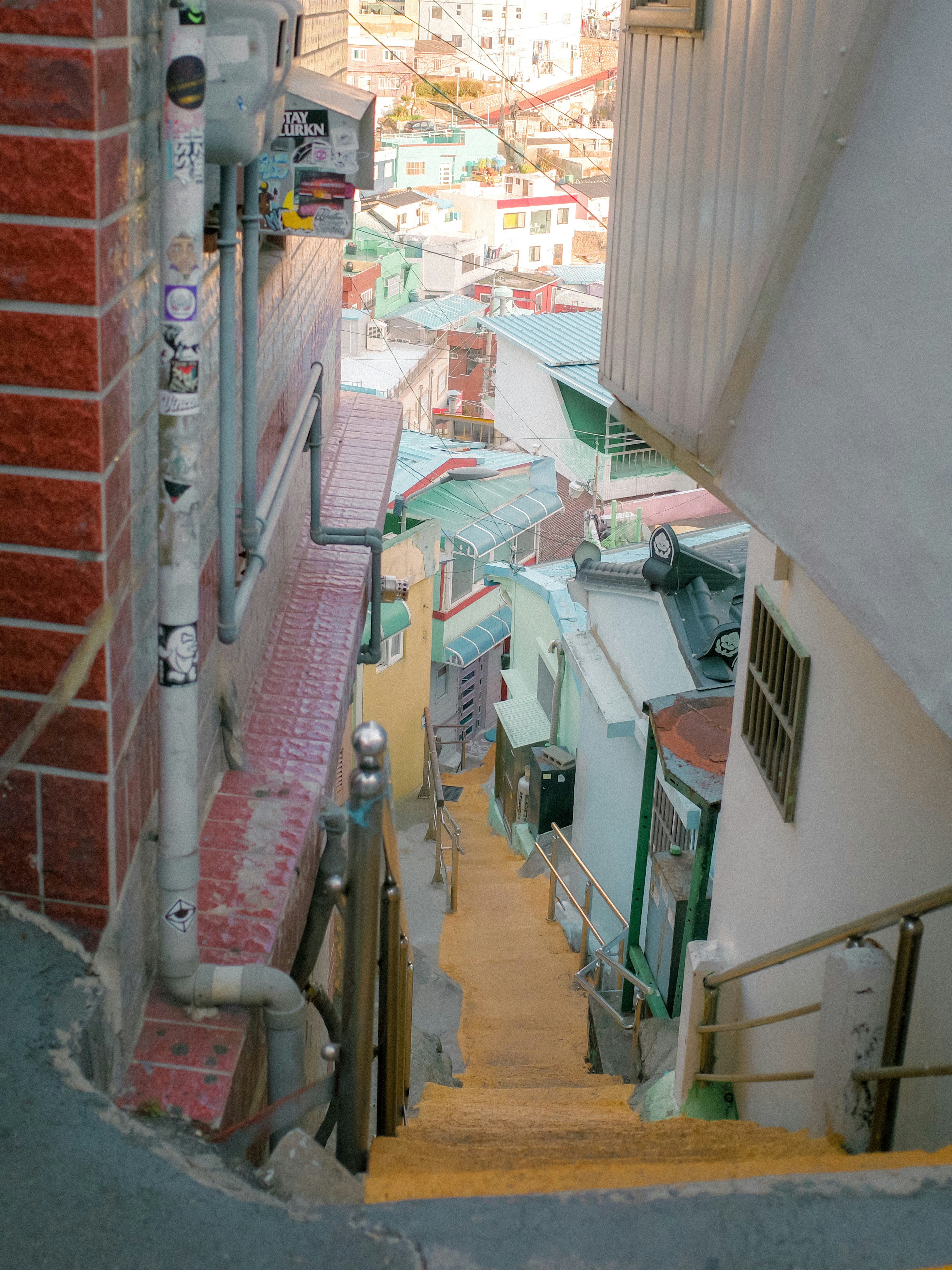Narrow staircase descends into a colorful neighborhood. photo – Free ...