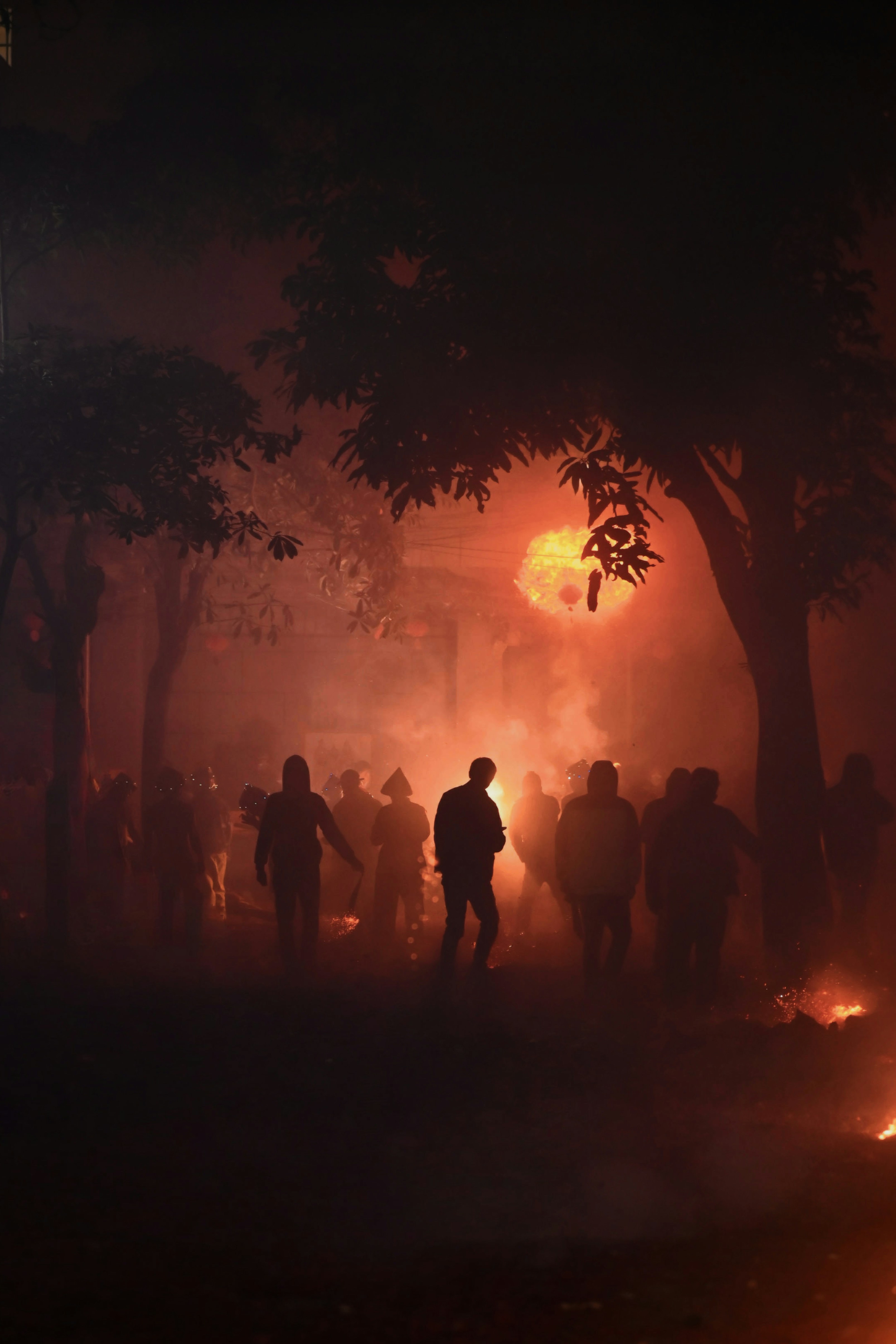 People gather at night with a fiery, orange glow. photo – Free China ...