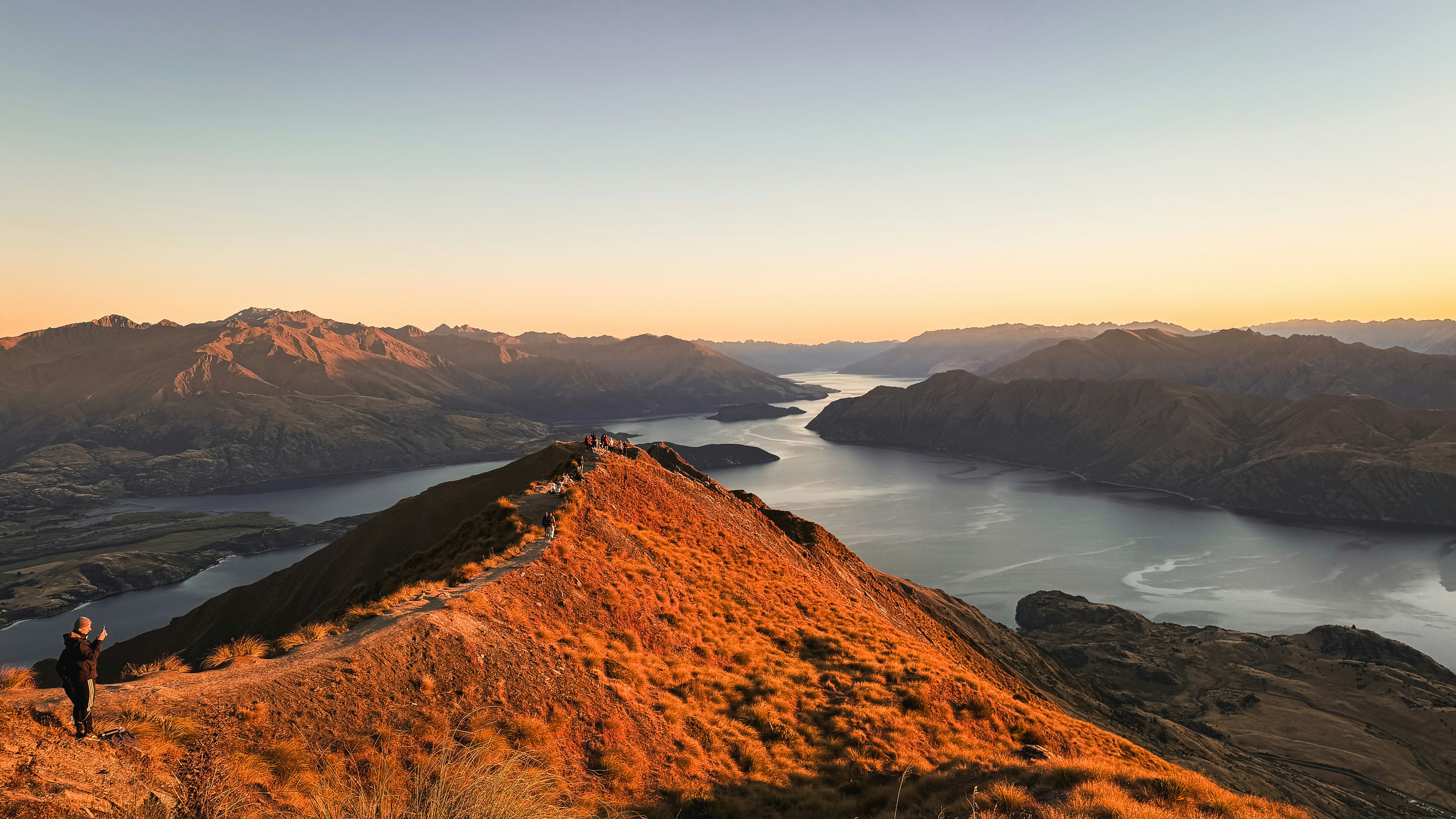 Sunlit Ridge Above a Serene Fjord