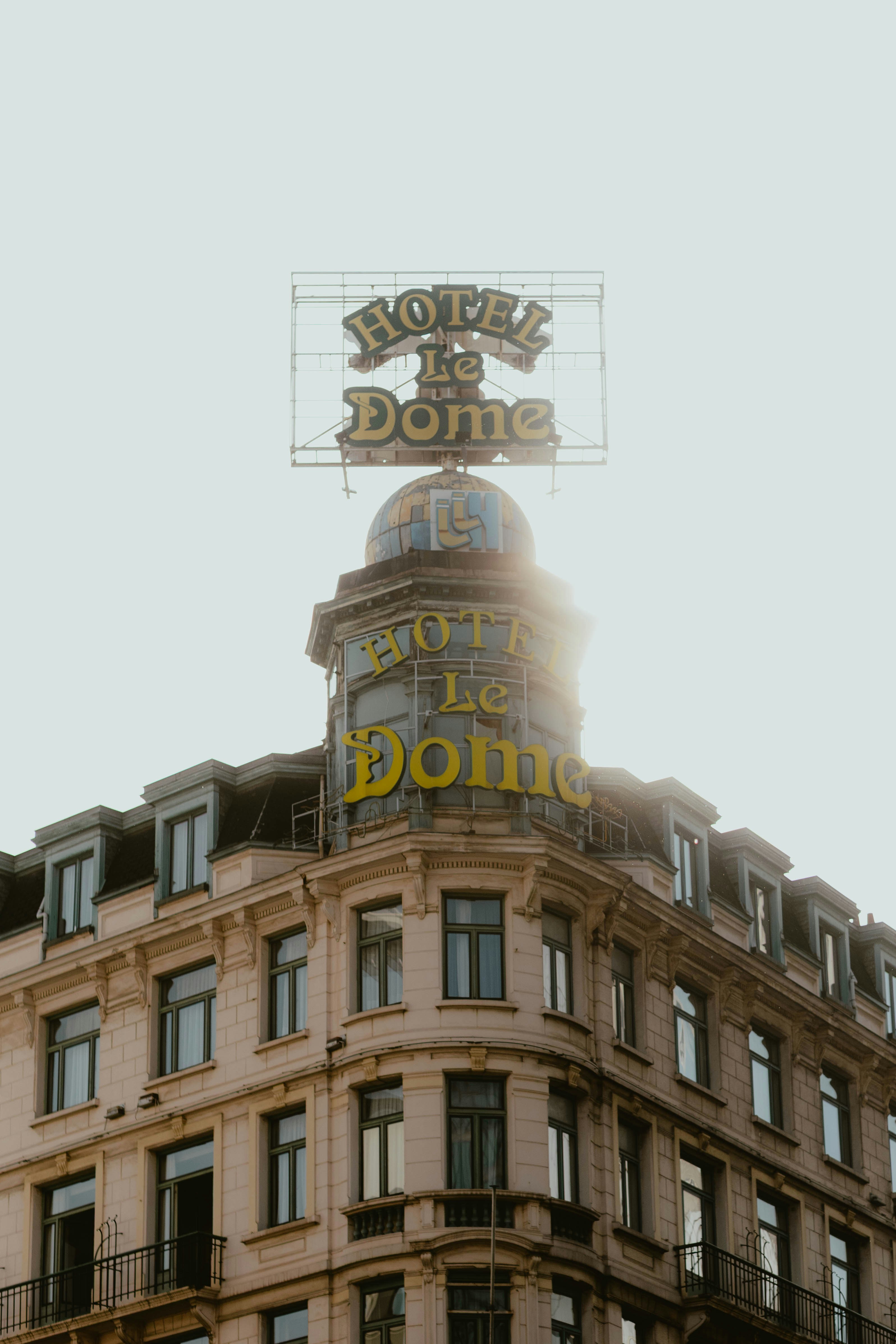Golden Signage Above the Dome: A Parisian Hotel in Morning Light