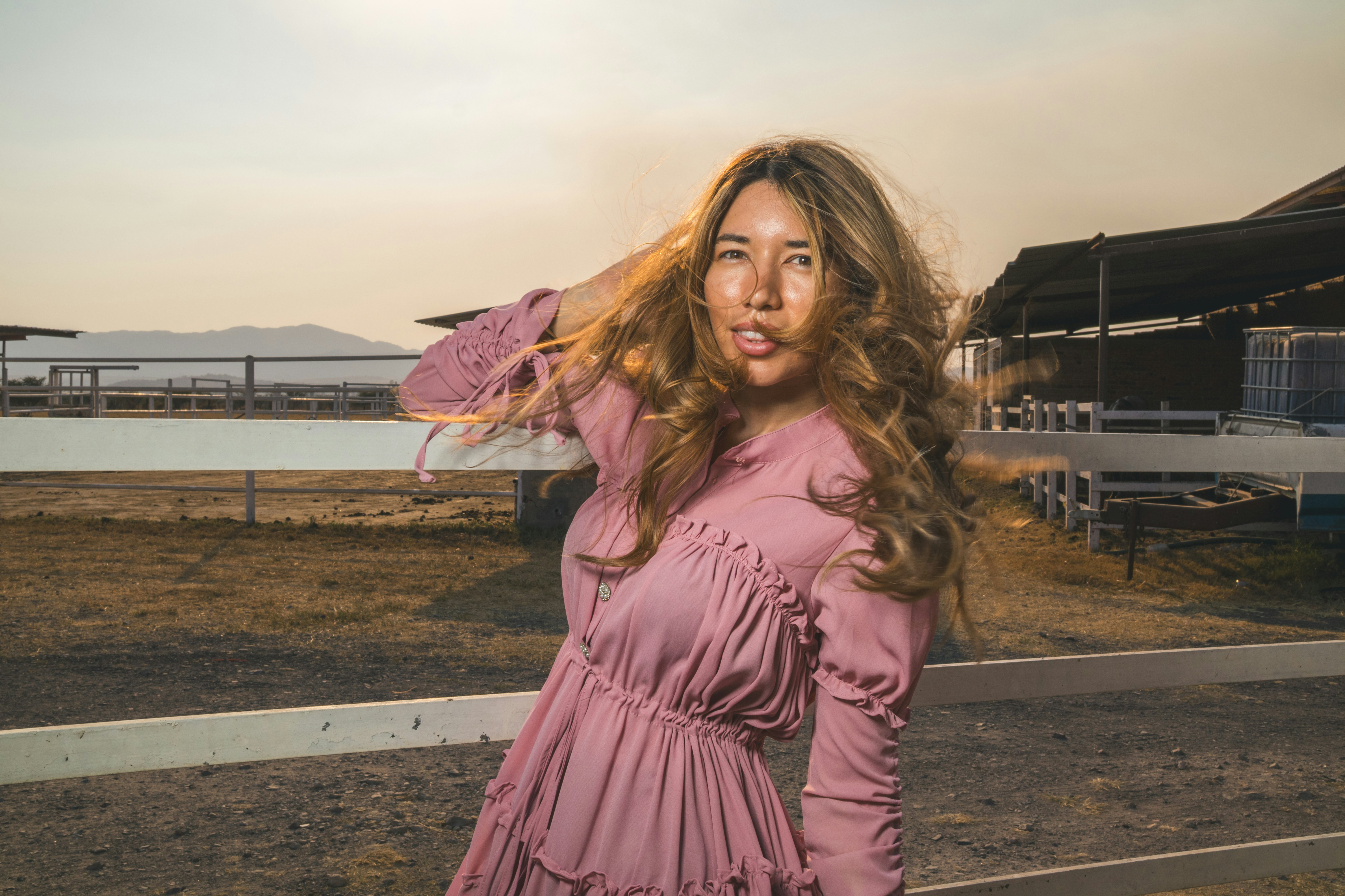 Sunlit Confidence: A Pink Dress Dance by the Shore