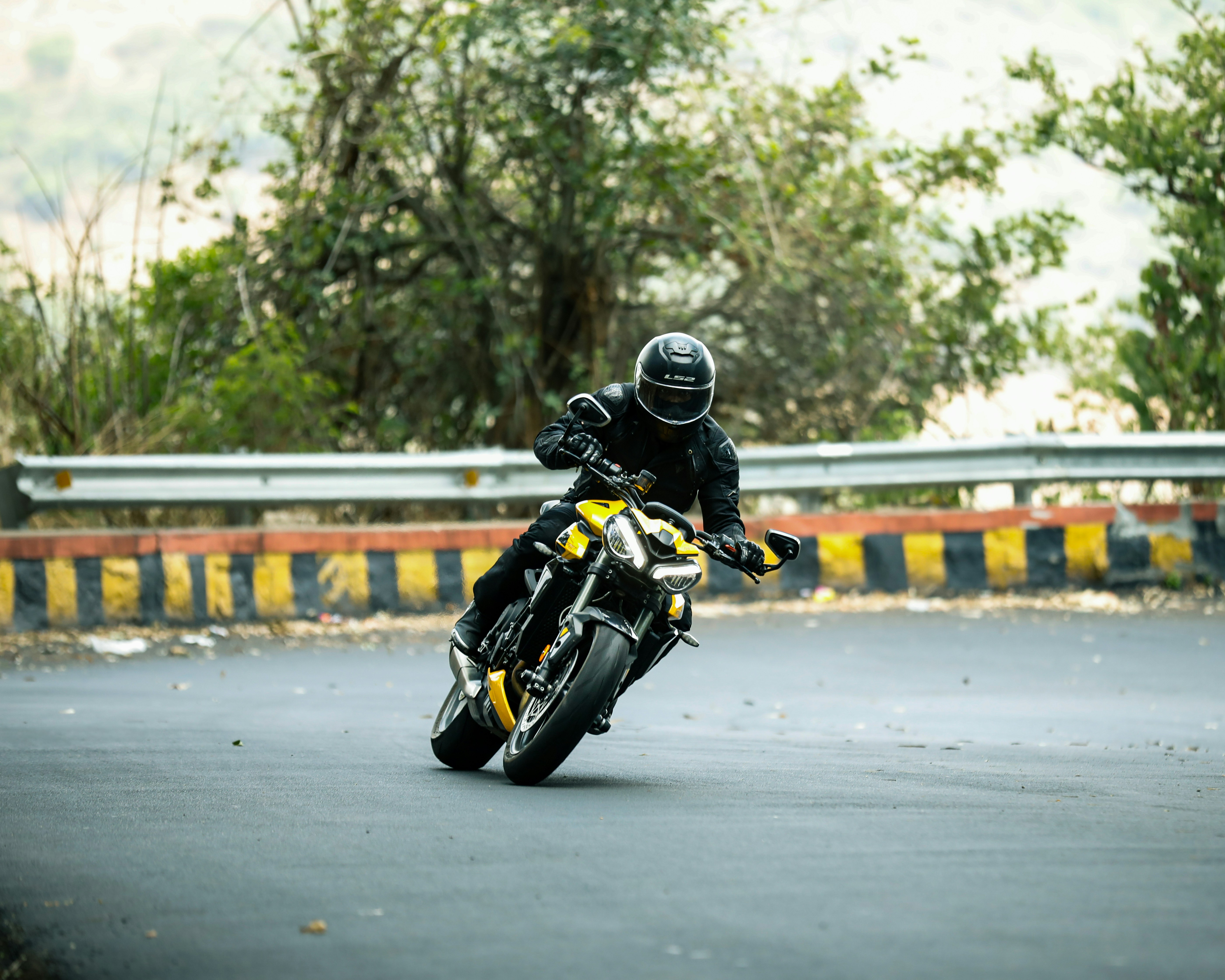 Lean Into the Curve: A Yellow-Accent Sportbike Banks Through a Guardrail Turn