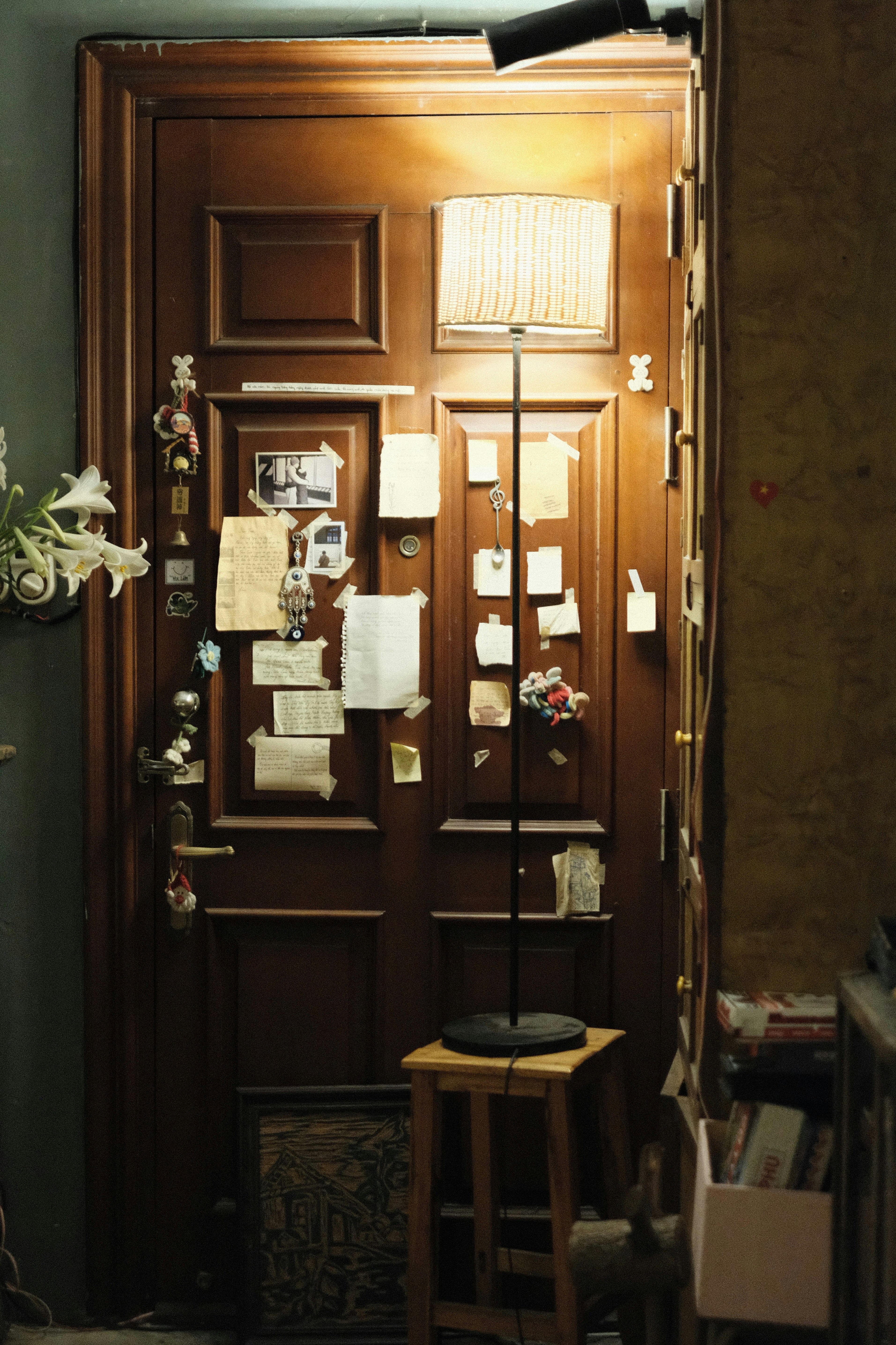 A wooden door adorned with photos and notes. photo – Free Human Image ...